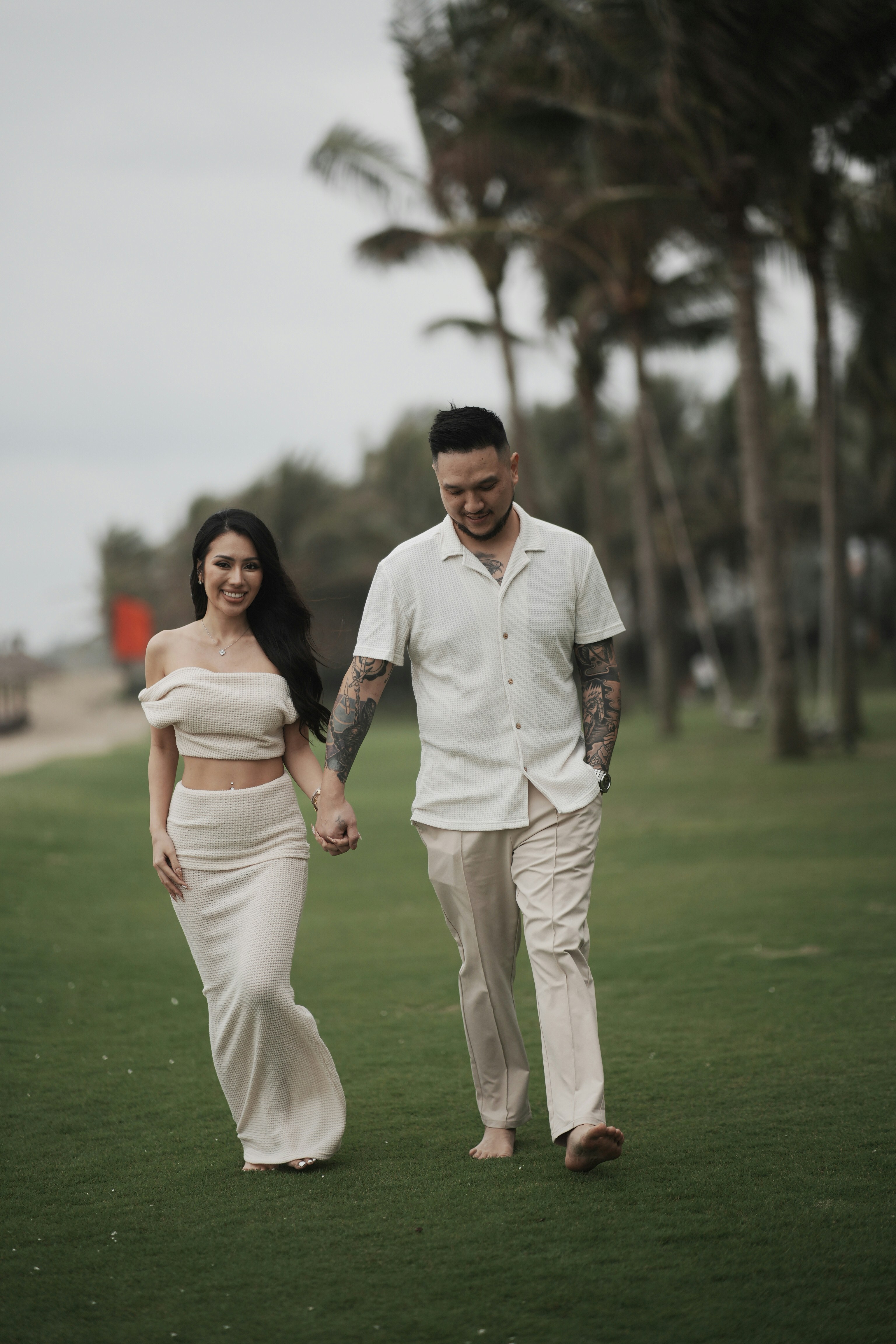 Holding Hands on the Green: A Casual Coastal Moment