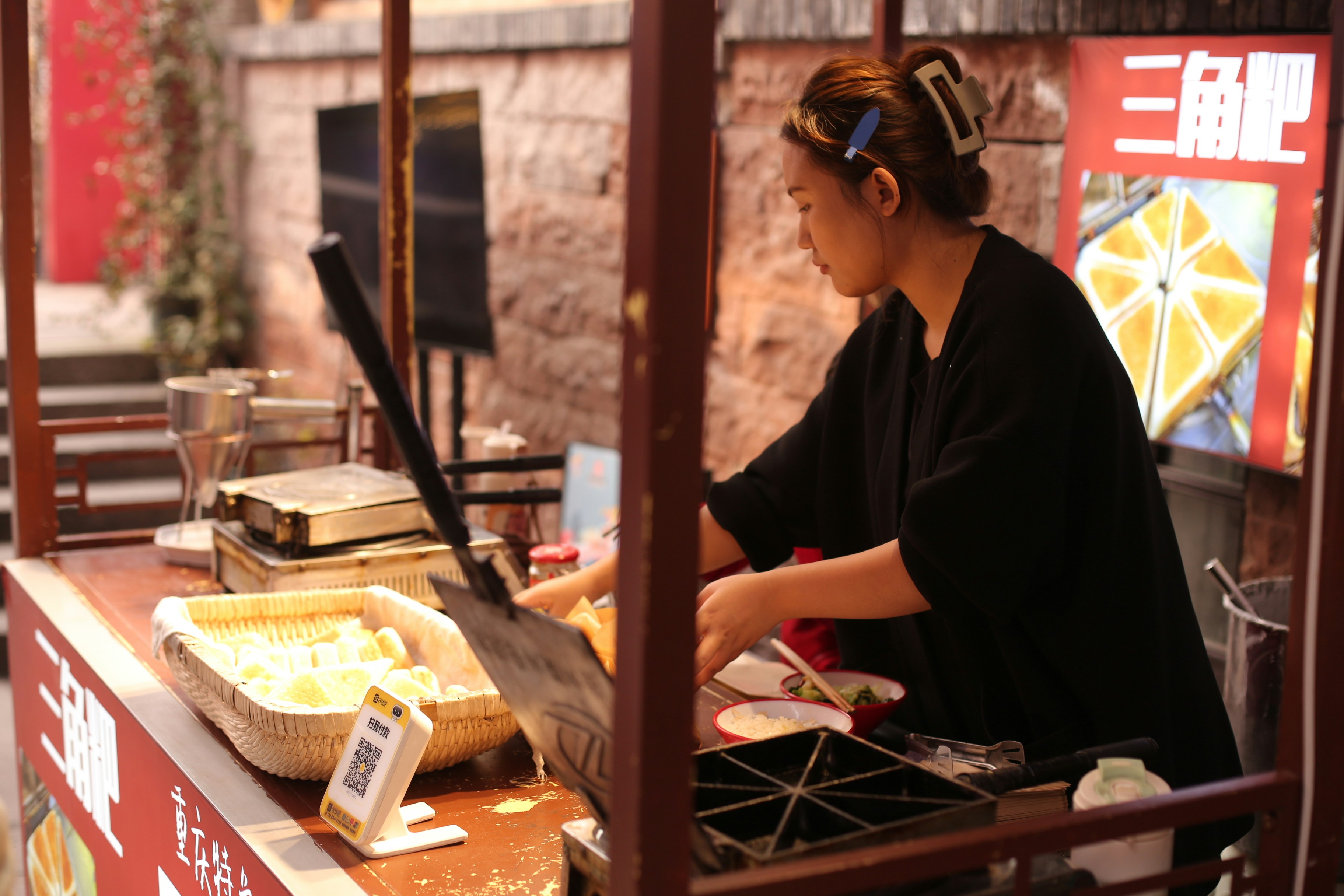 Street-side chef: preparing skewers under warm booth lighting