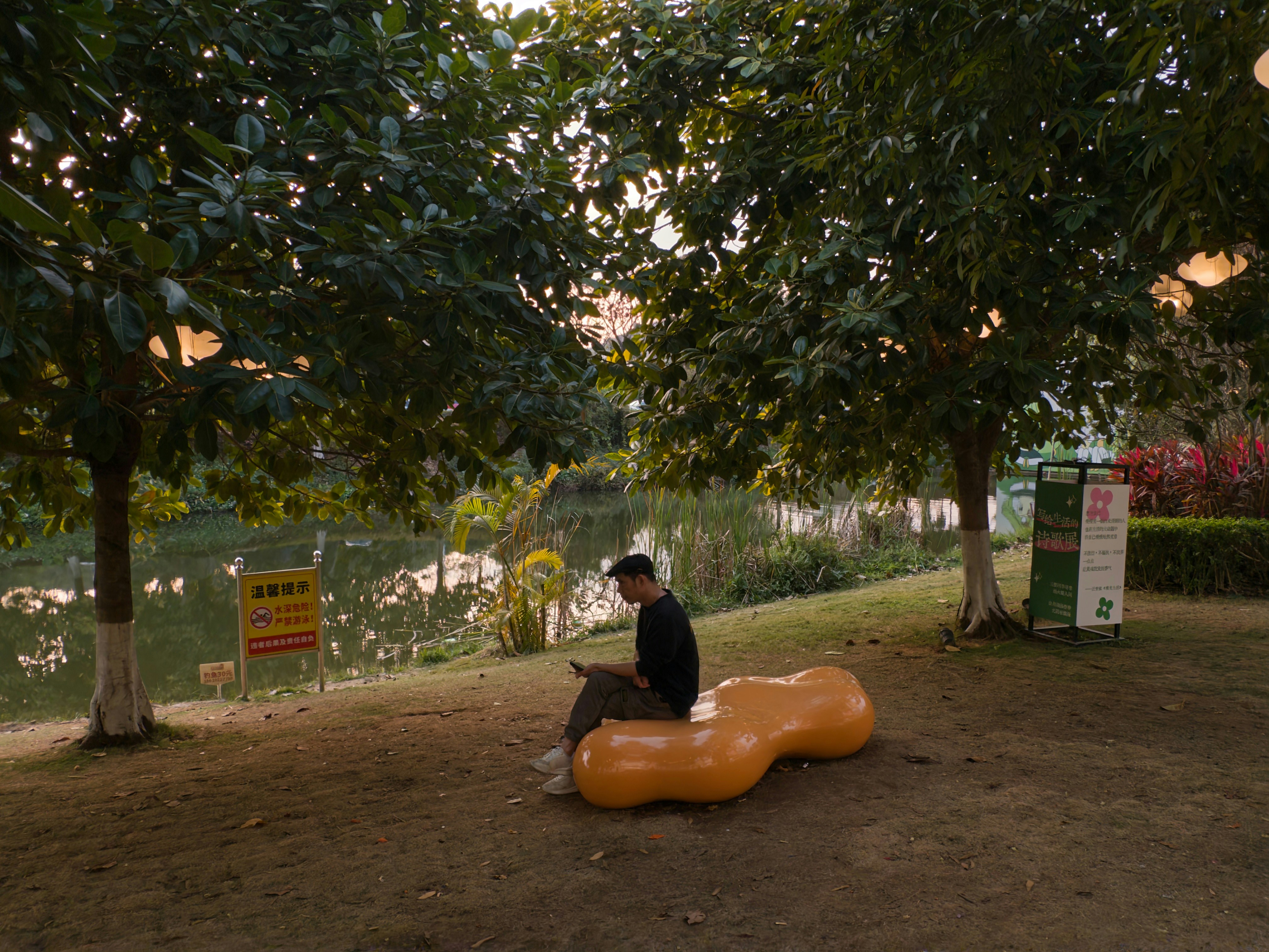Quiet Moment on an Orange Bench by the Pond