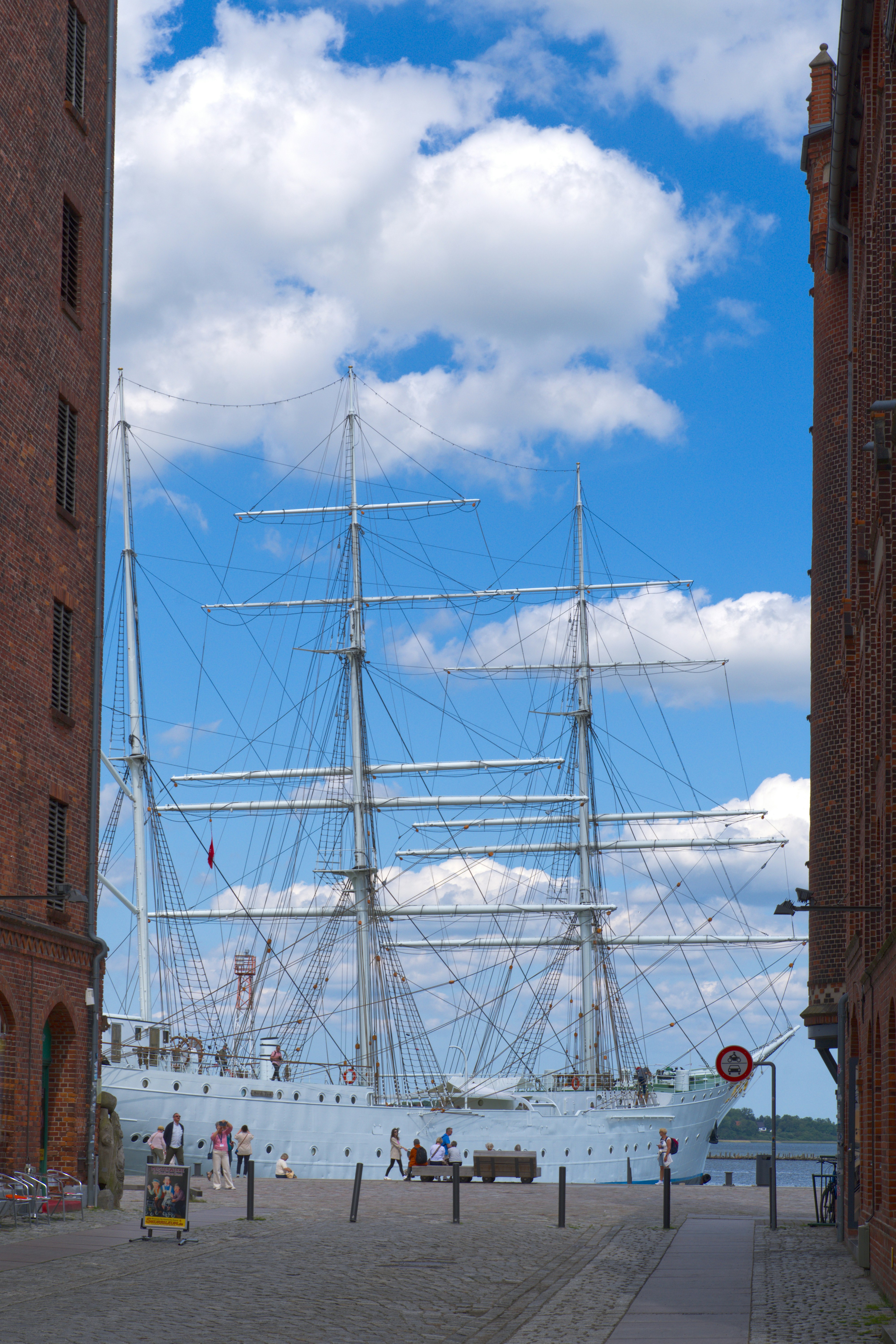 Portrait Gate into the Sail Fortress: A Docked Ship Framed by Brick Archways