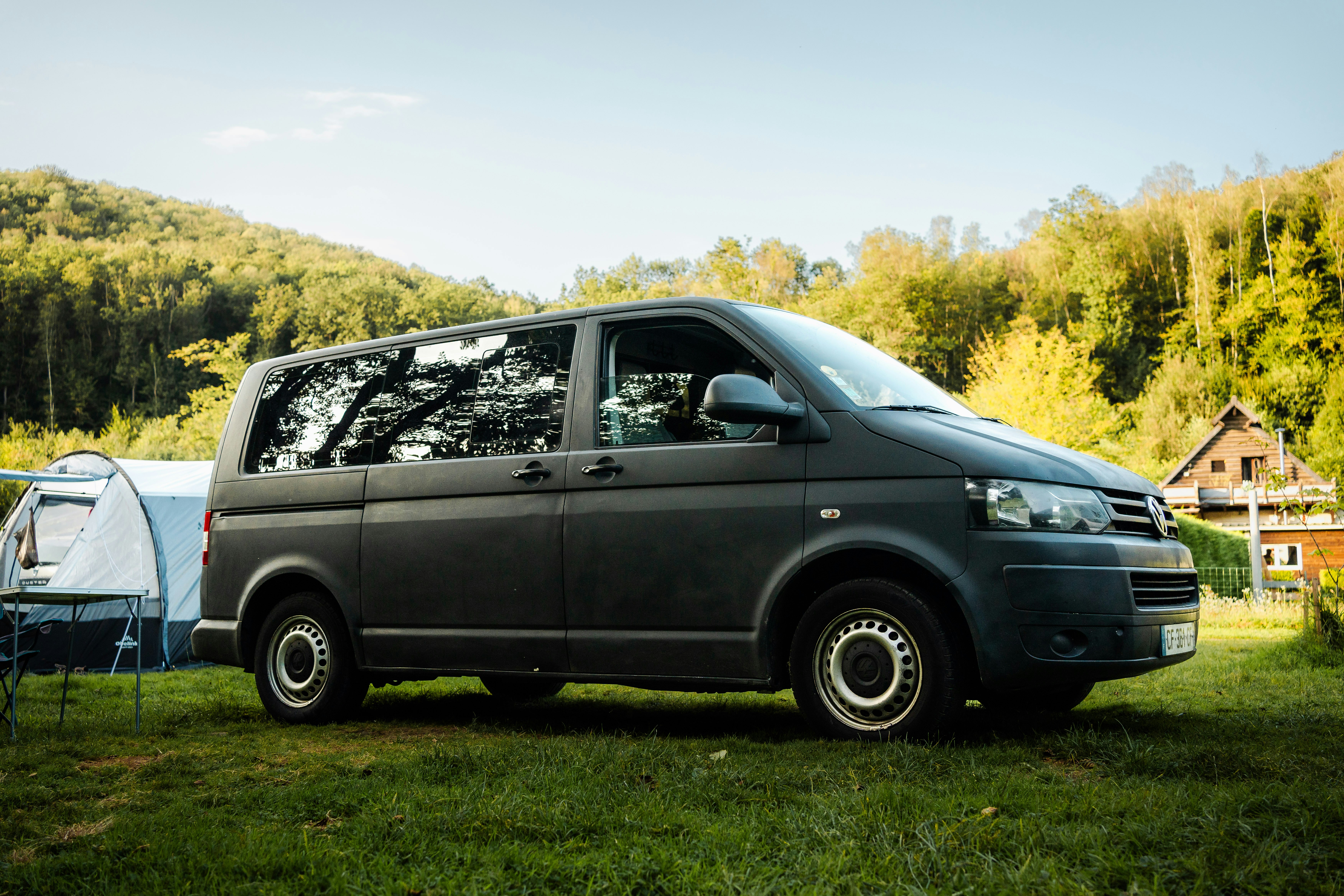 Casual Camper: A Dark Van Atop Sunlit Grass