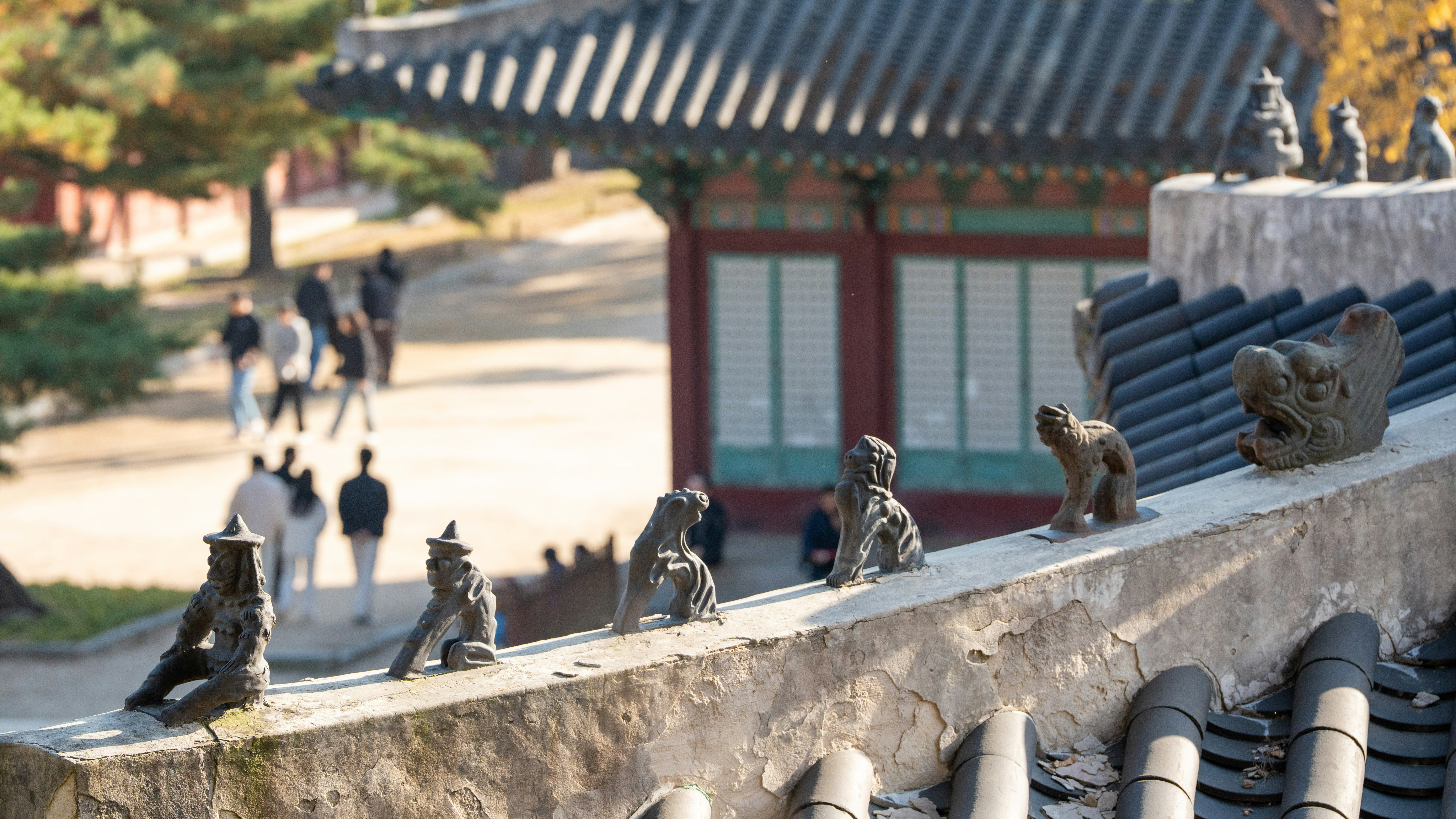 Row of stone guardian figures guard the roof edge of a traditional Korean temple