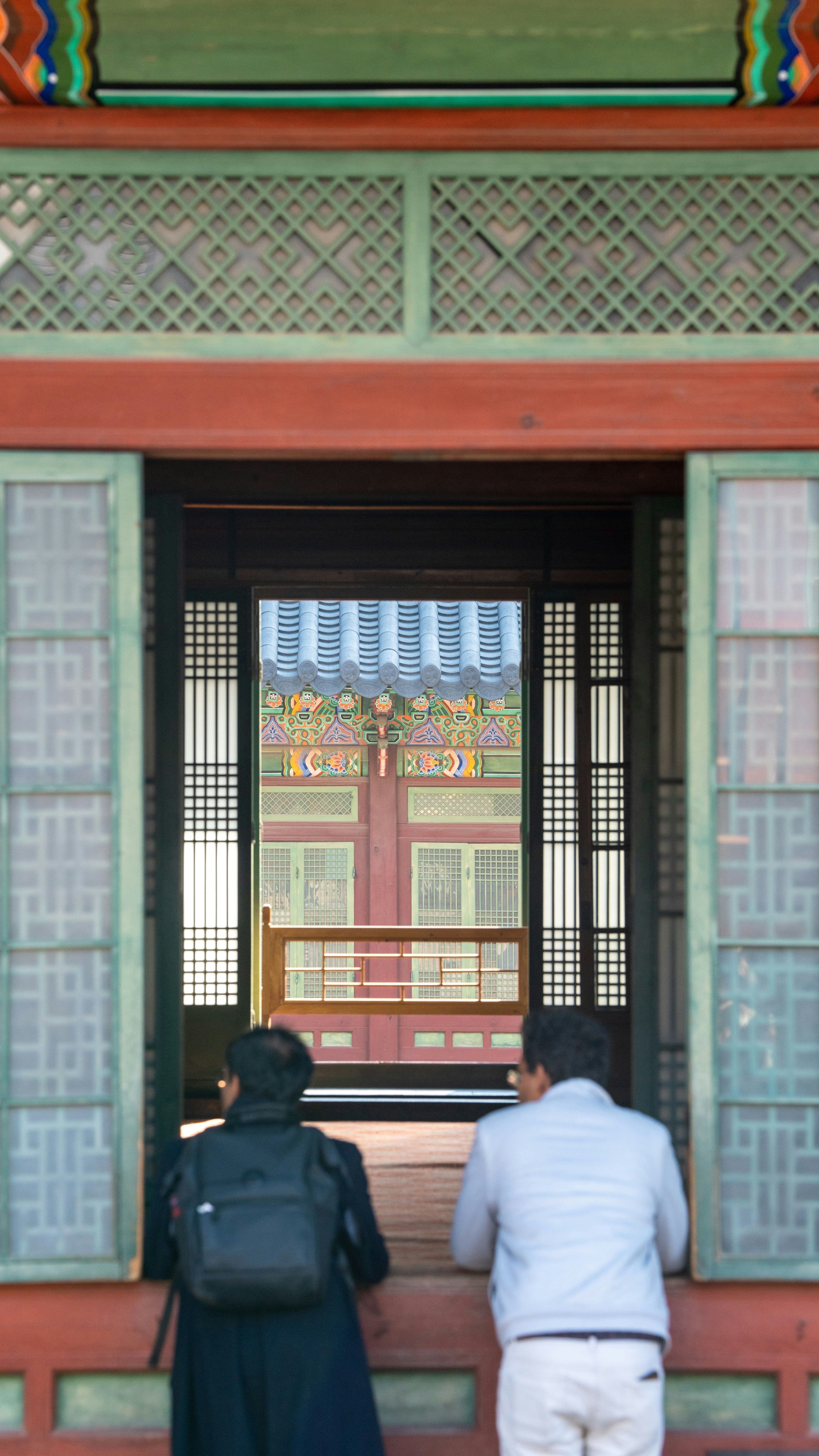 Entering the Painted Corridor: Travelers at a Korean Temple Threshold