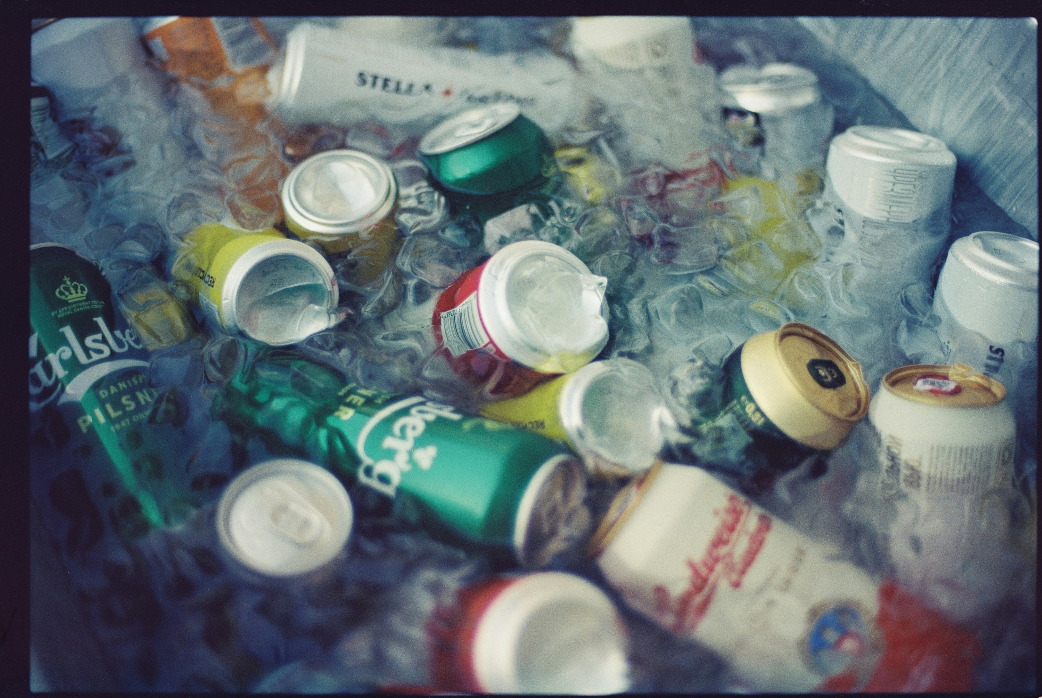 Assortment of beer cans in ice.