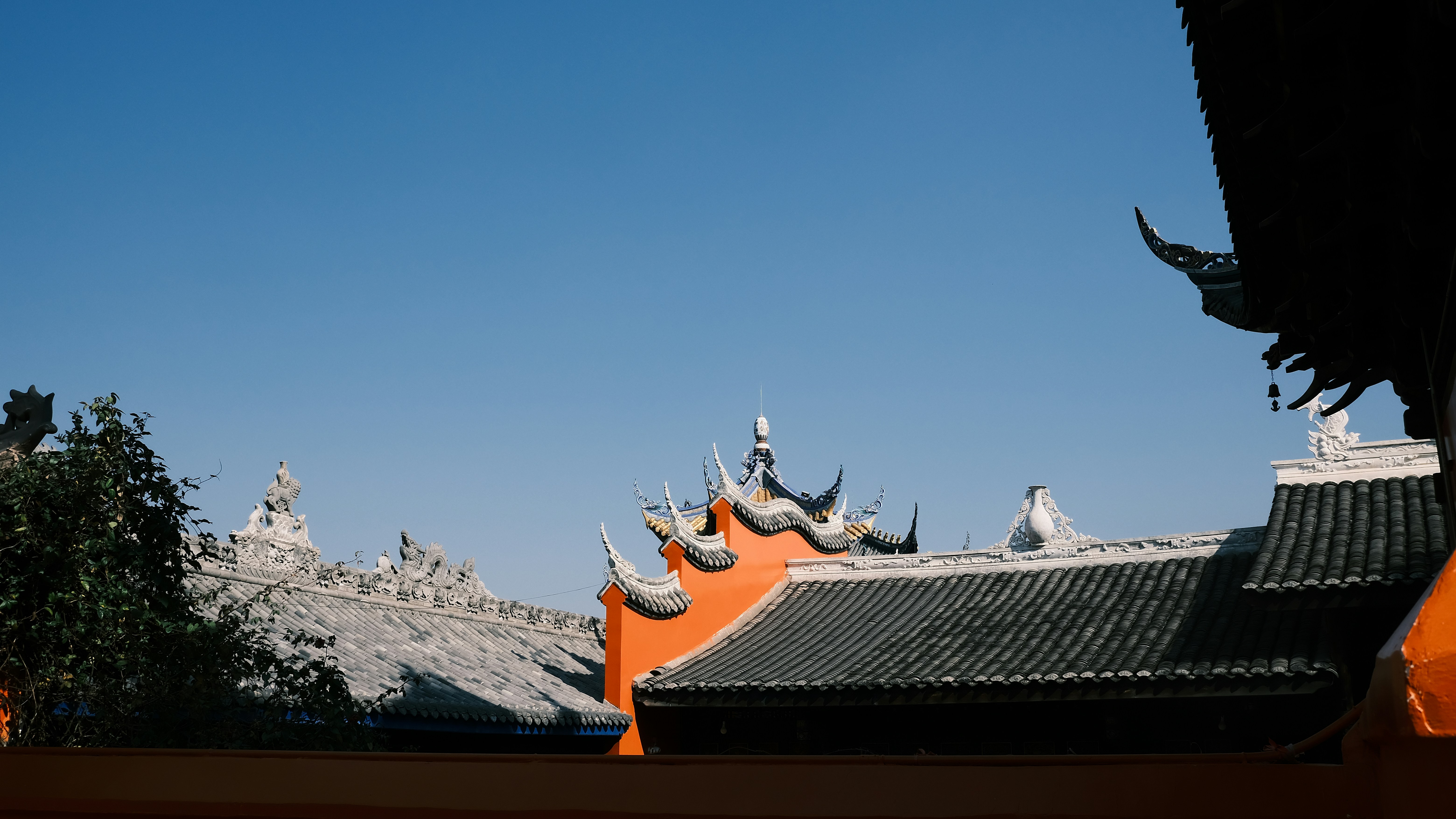 Orange-Topped Pagoda Against a Clear Blue Sky