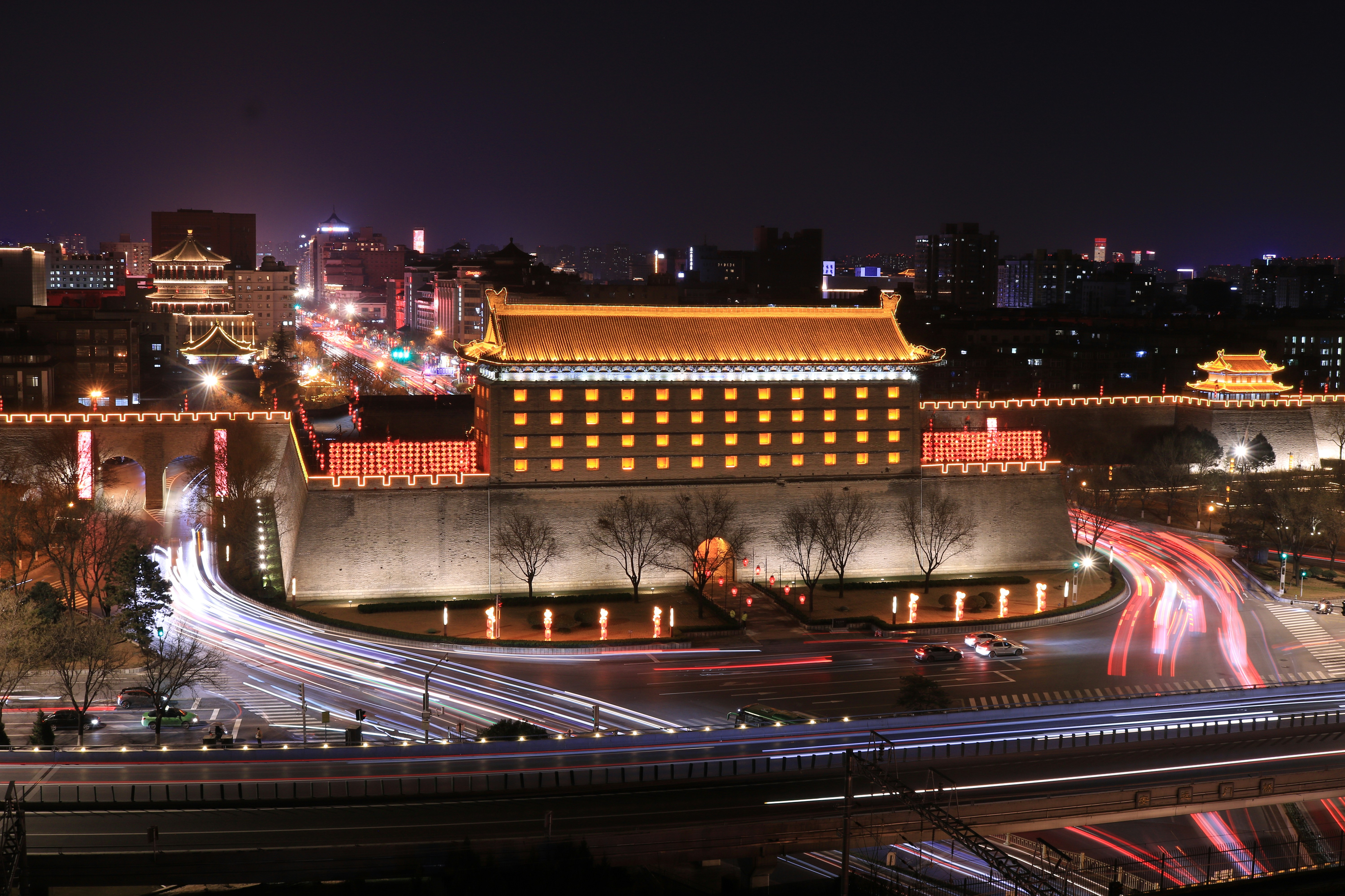 Illuminated City Gate: Nighttime Fortress Beneath the Streetlights