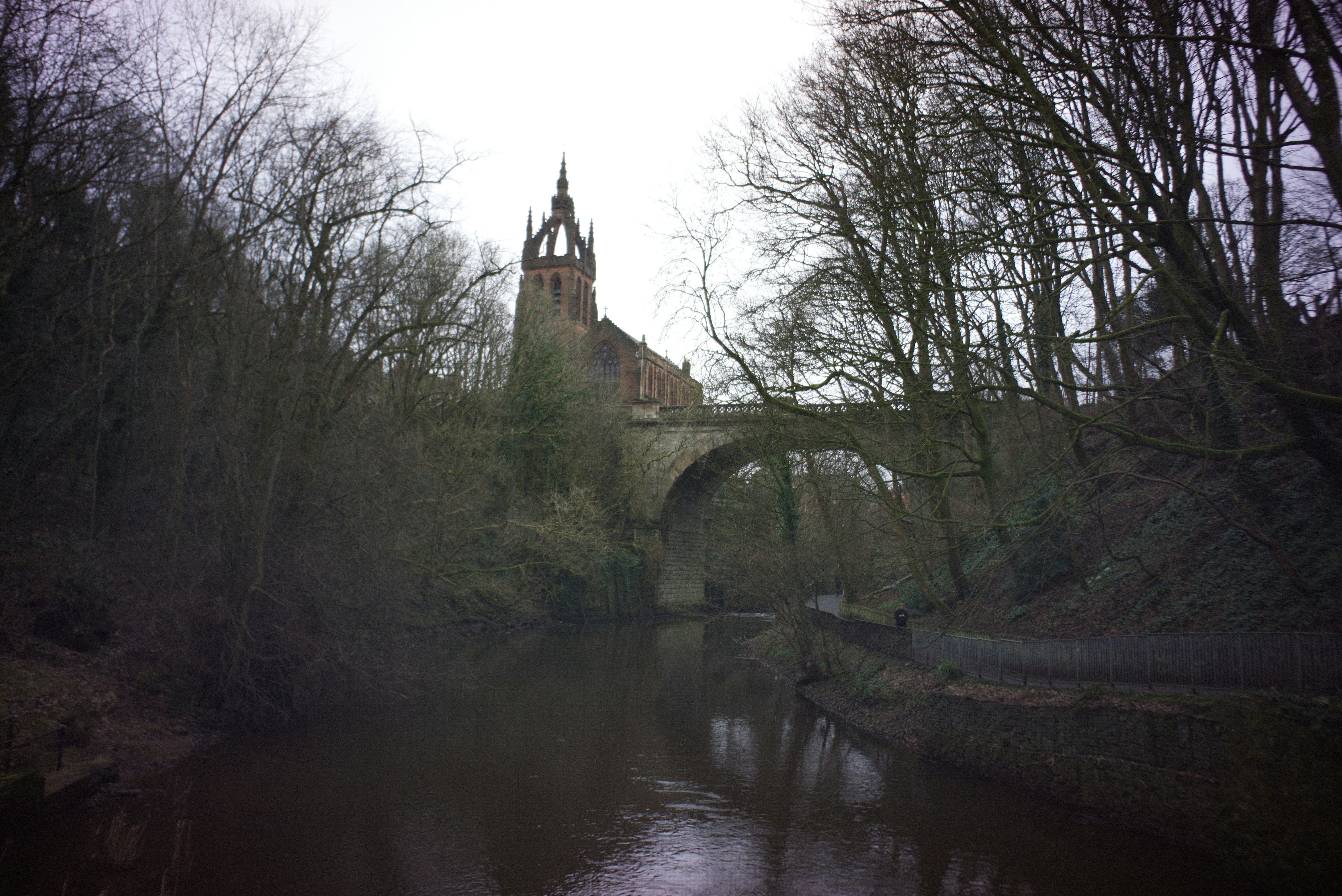 Bridge and Cloistered River: A Gothic Bell Tower Overcast