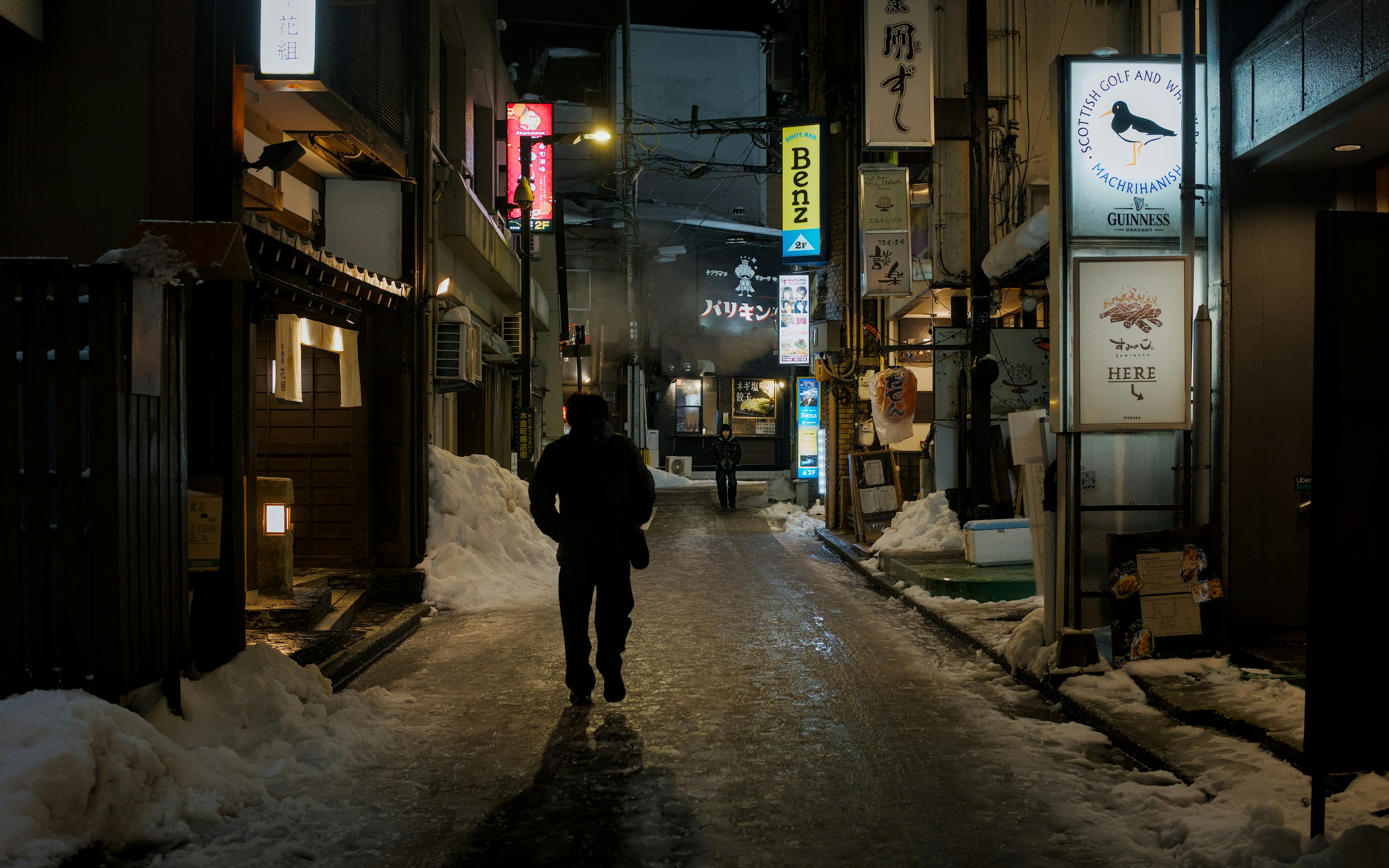 Midnight Wanderer in a Snow-Dusted Alley