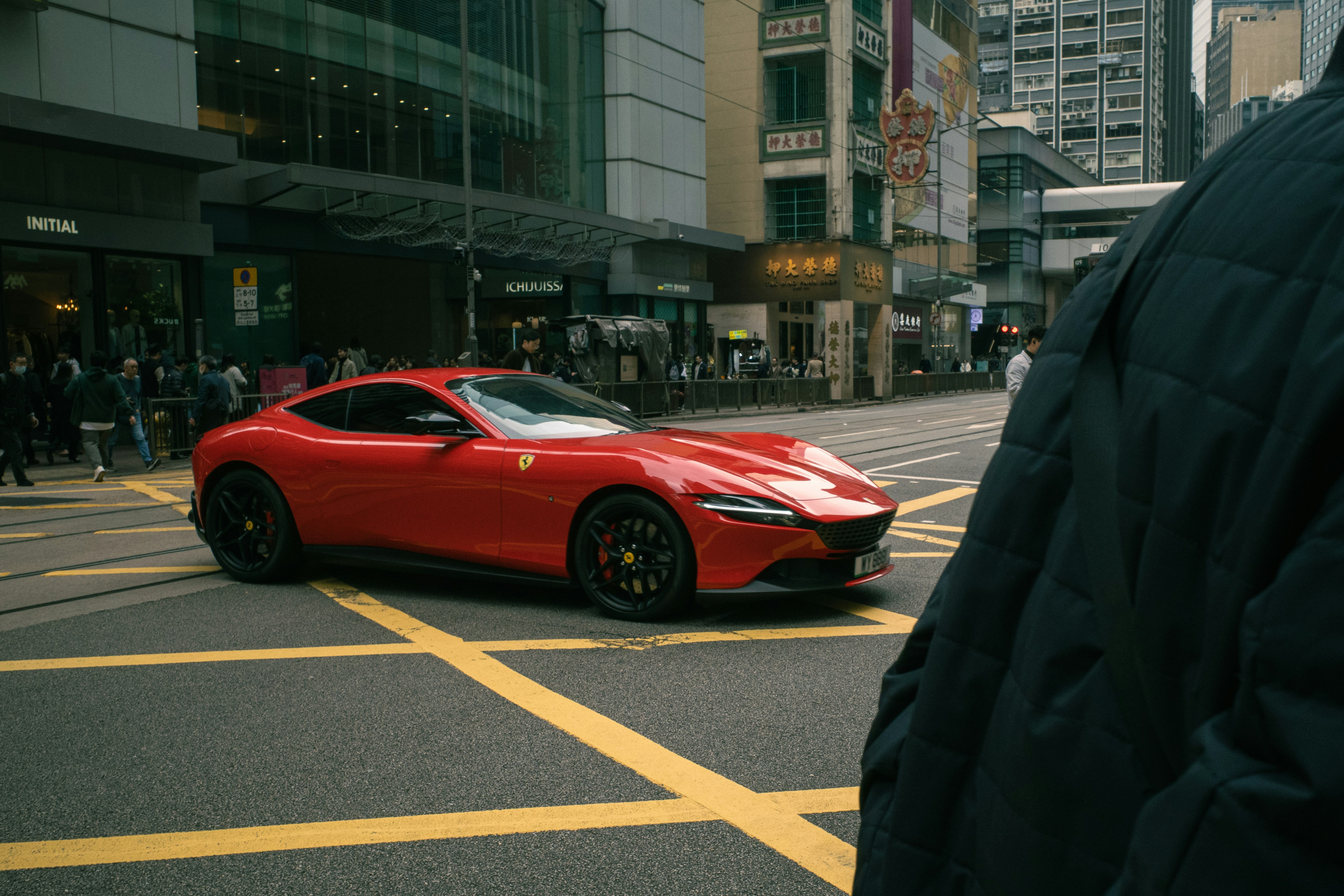 Crimson Hypercar in an Urban Crosswalk