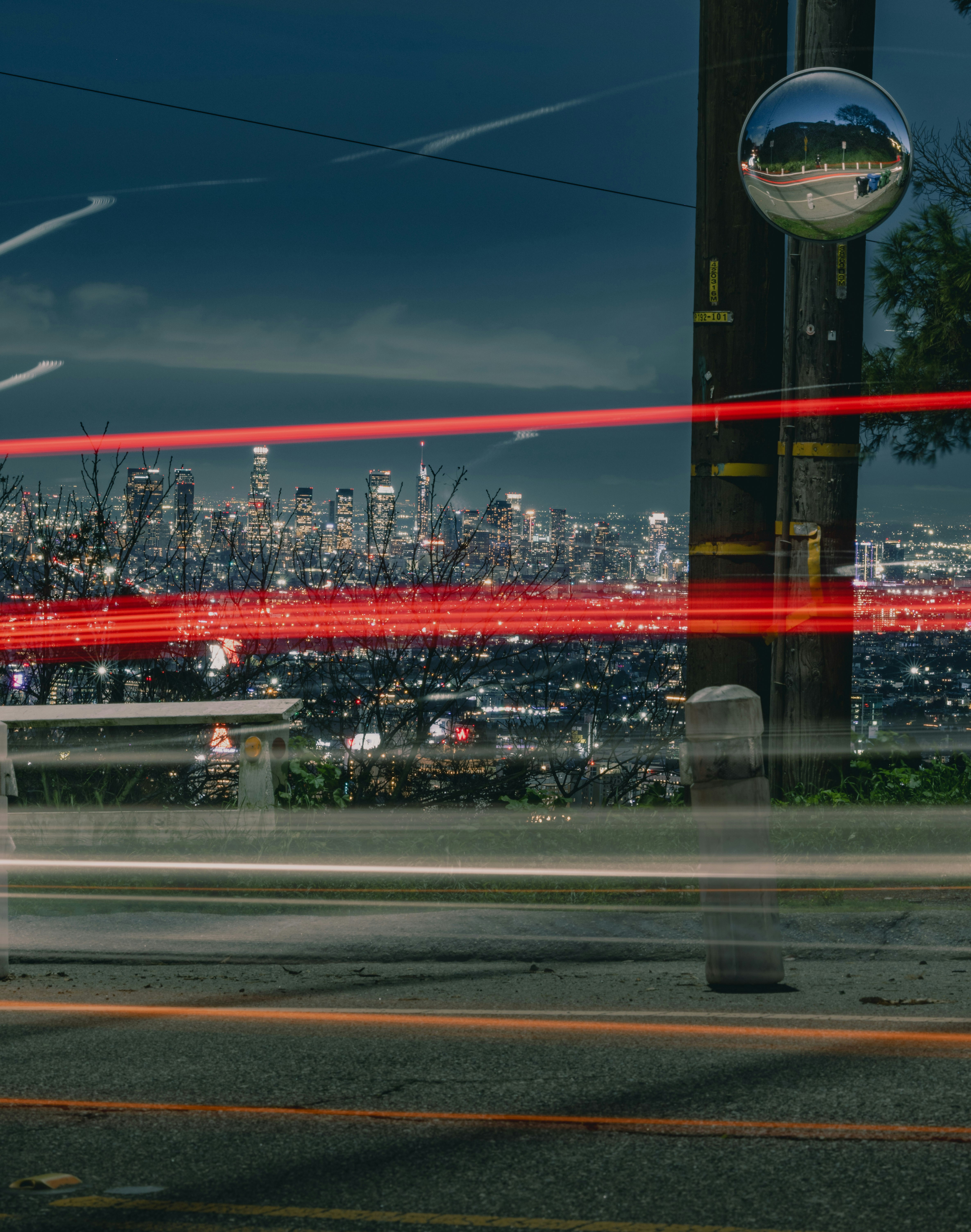 City Lights in Motion: Red Streaks Across a Nighttime Skyline