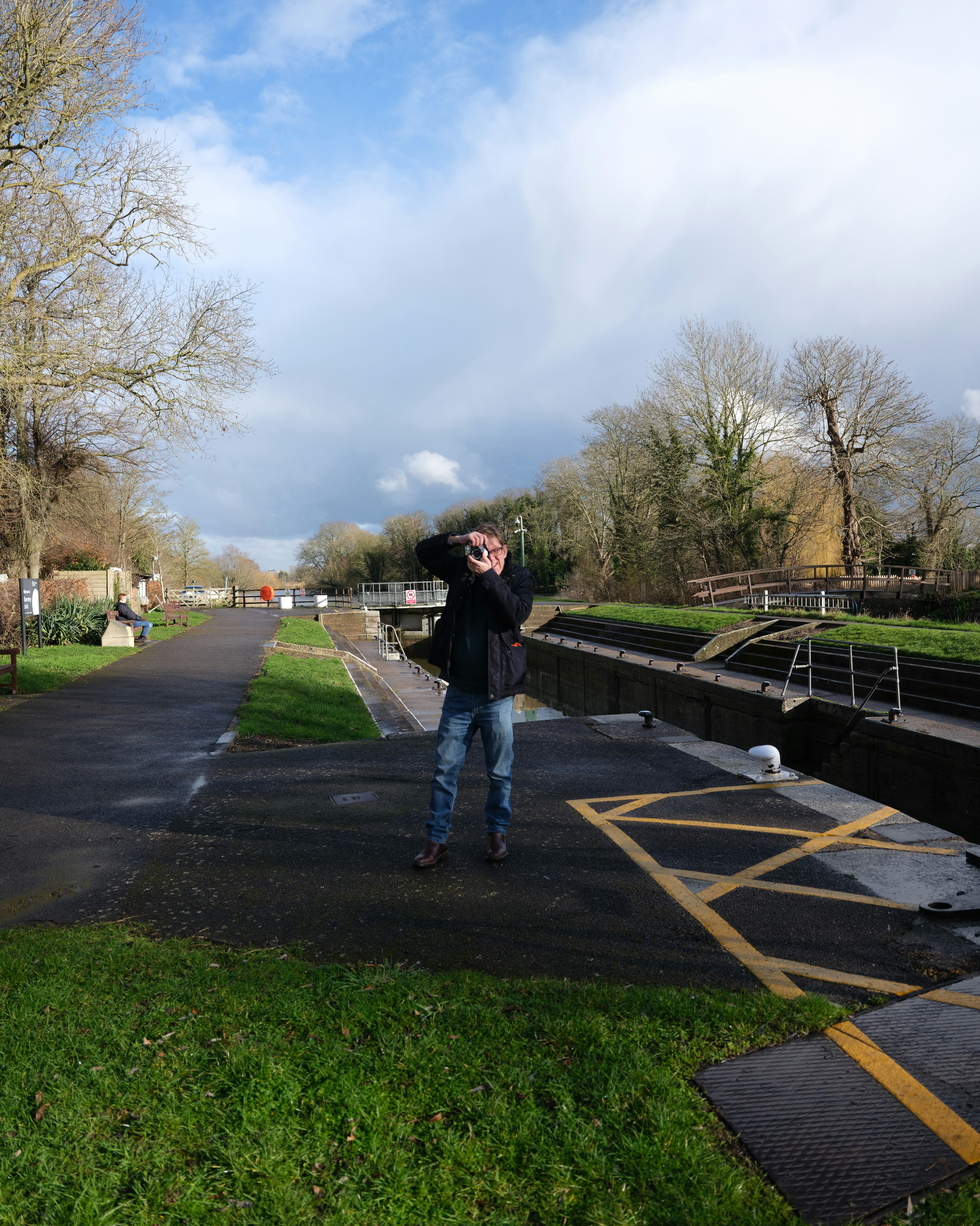 Photographer on the Canal Walk: A Solo Portrait Amid Quiet Waters