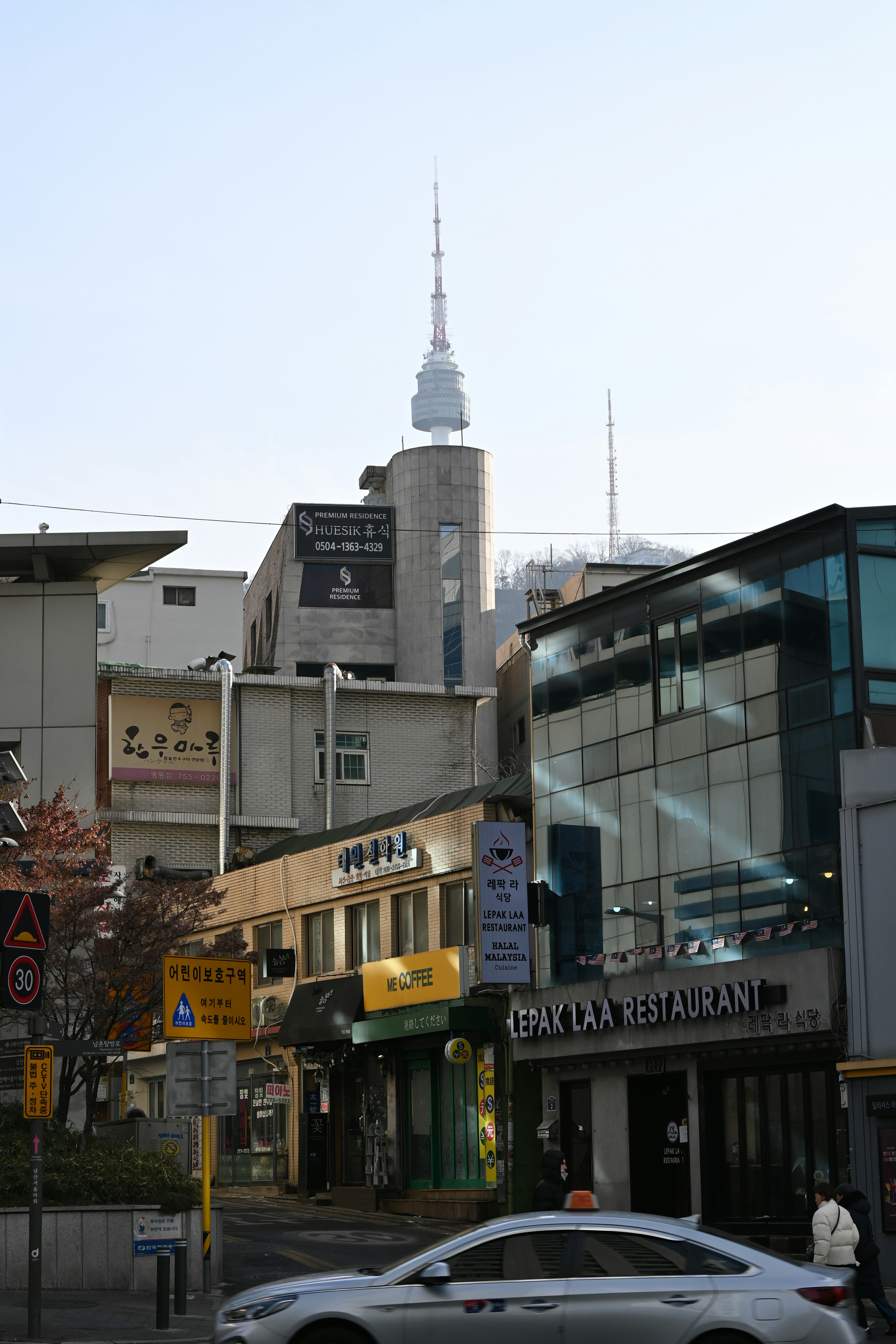 Urban Skyline Spine: A Tower Stands Above a Narrow Street