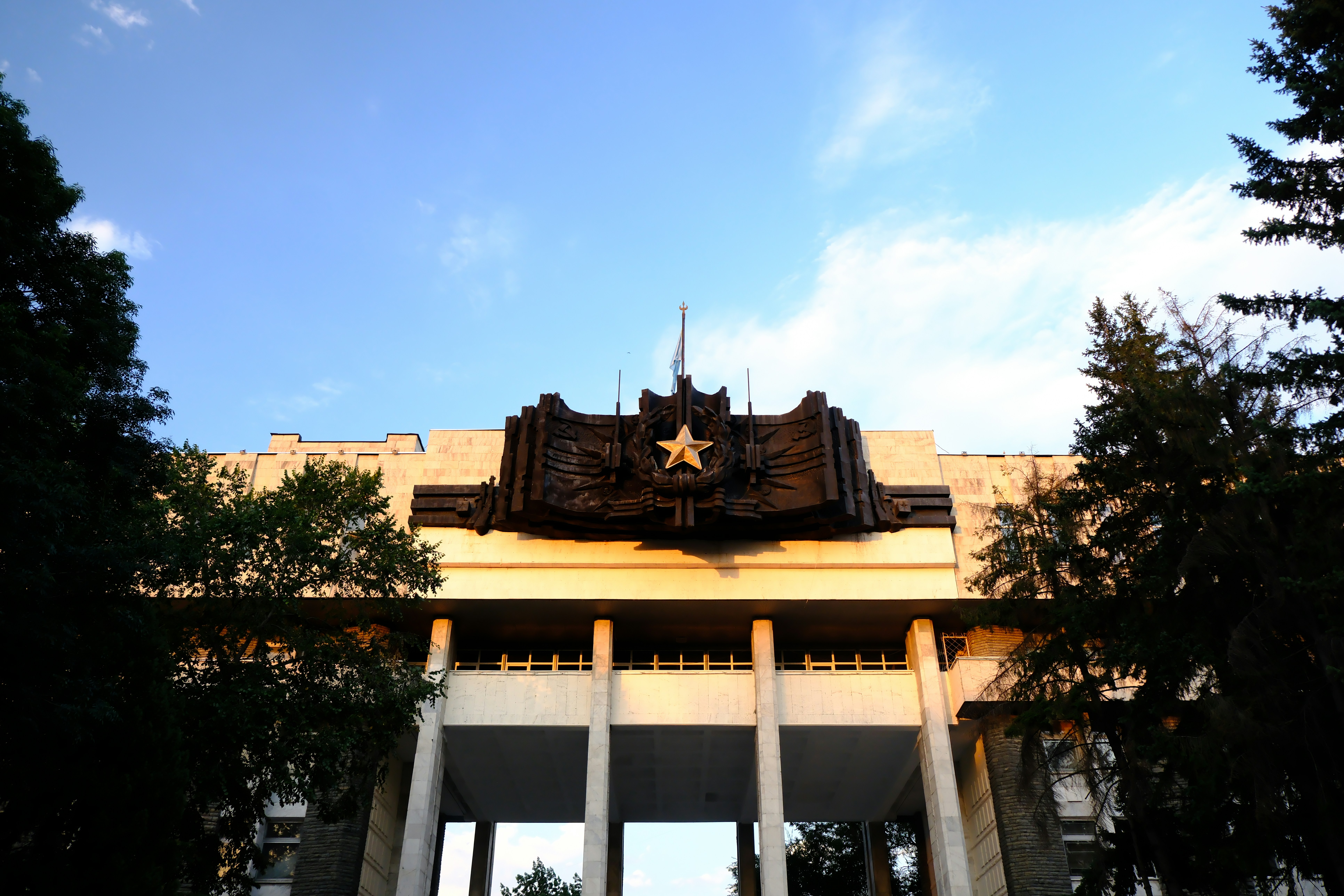 Starcrest Gate: A Monumental Emblem Framed by Pines