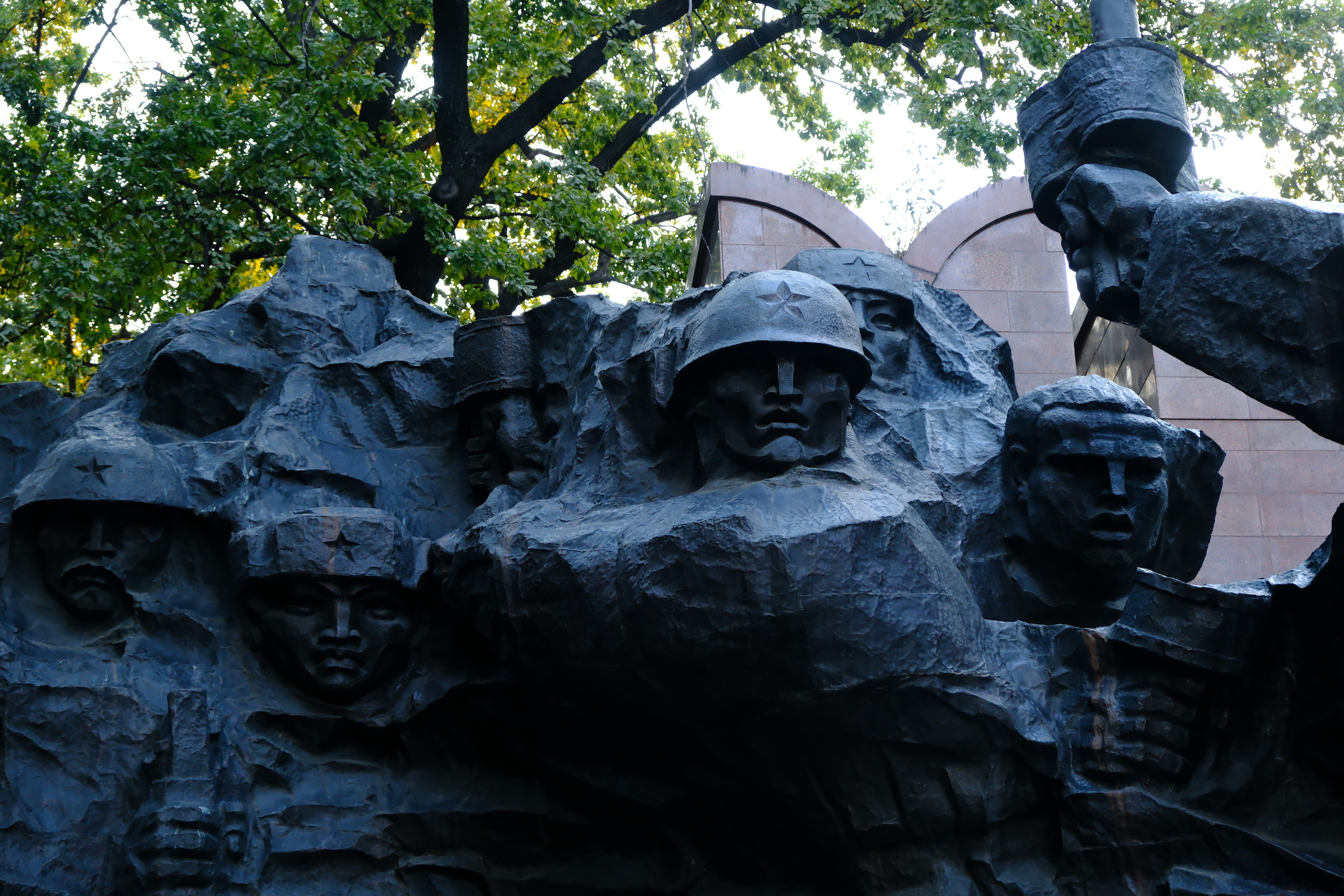 Stone Chorus: Faces Emerging from the Monument
