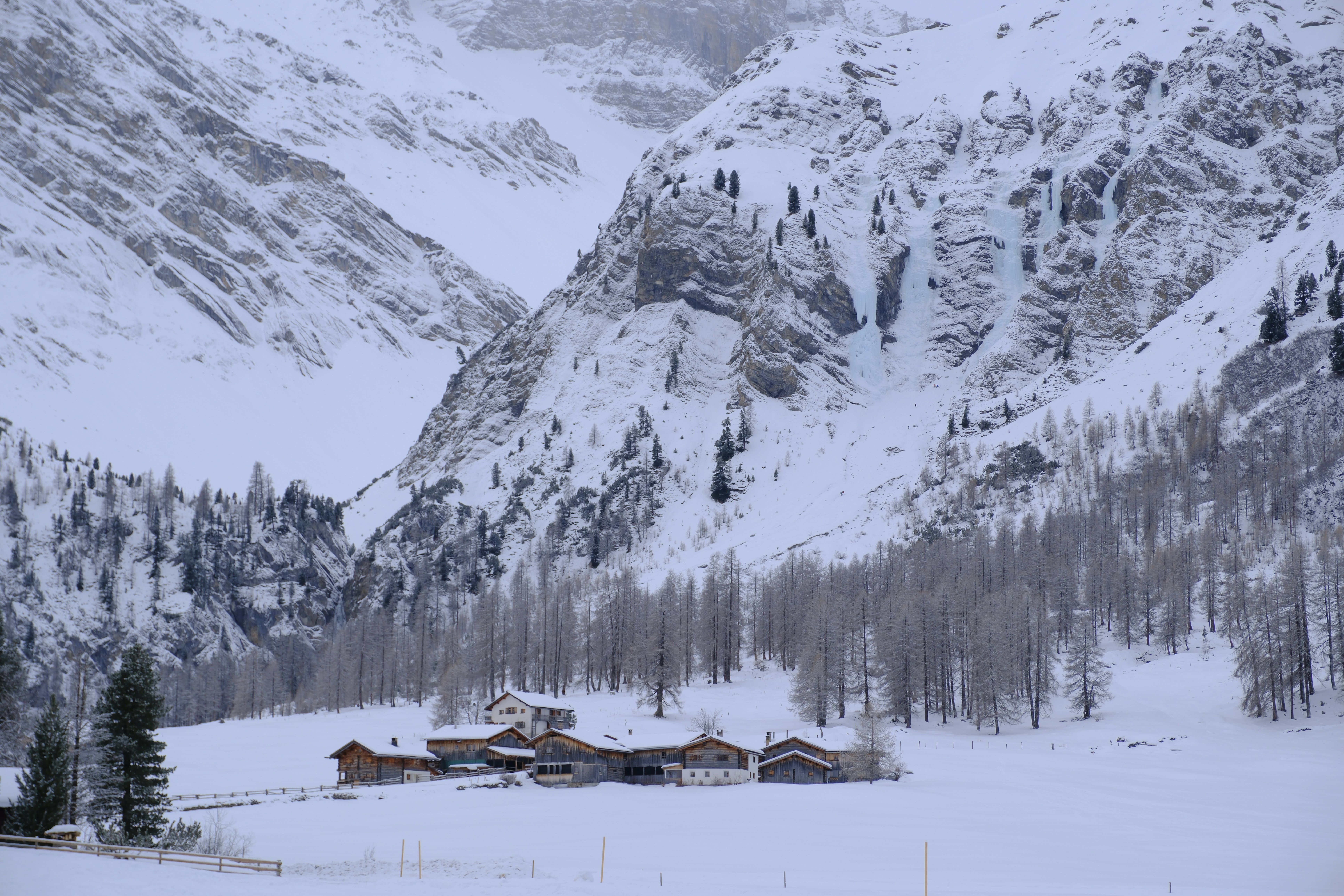 Snowbound Alpine Village Beneath Towering Glacial Peaks