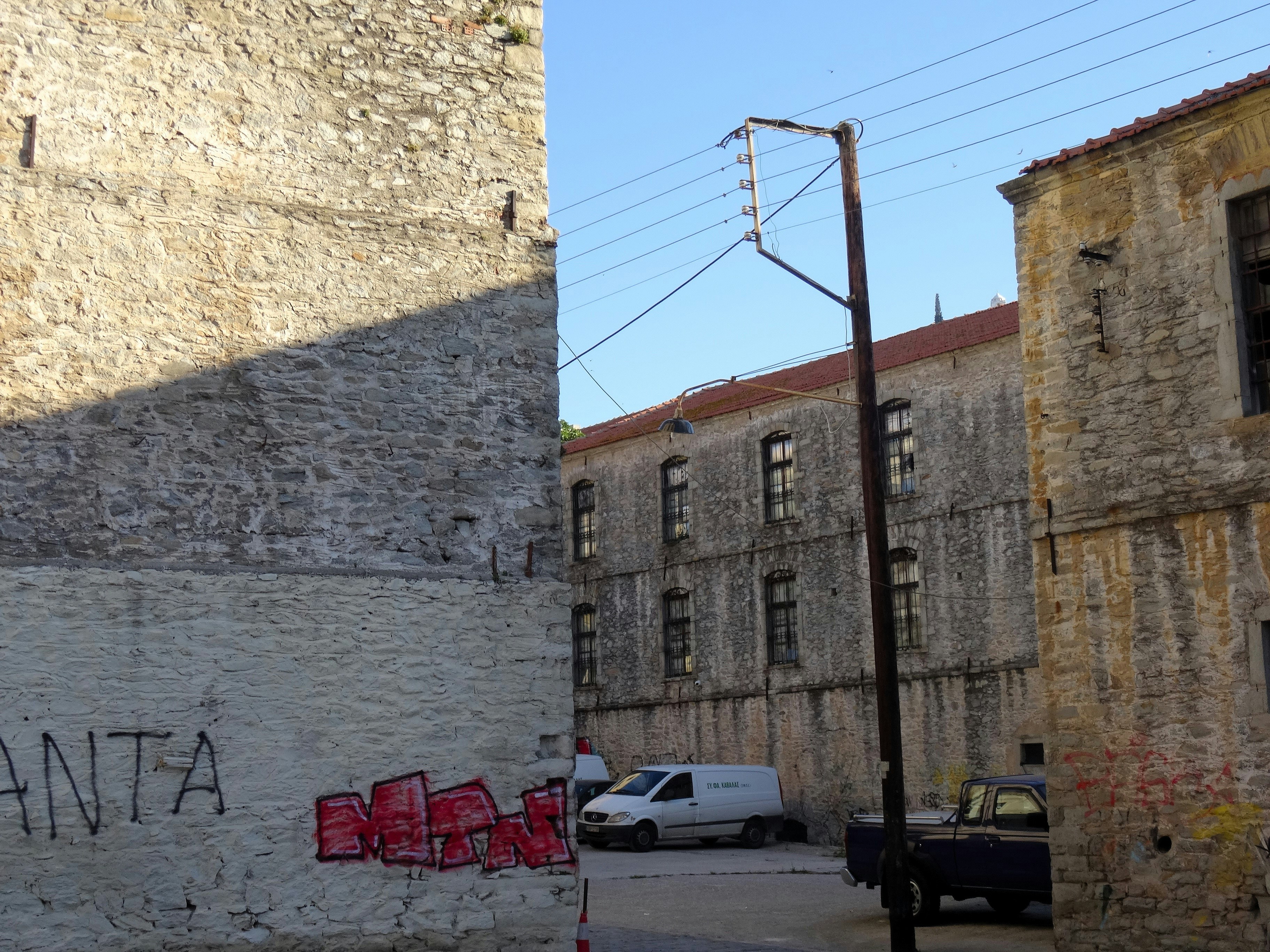 Old buildings and a utility pole on a sunny day
