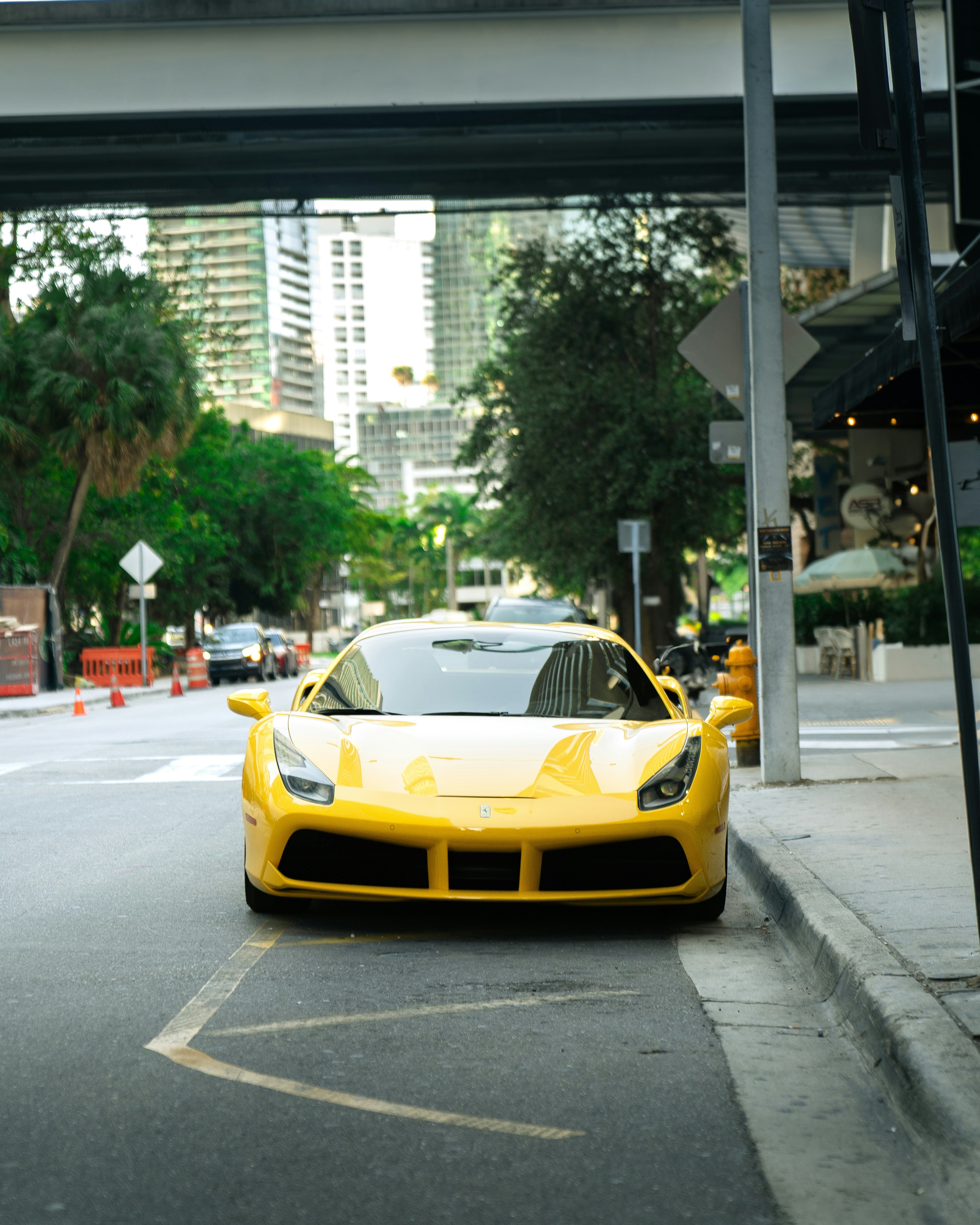 Yellow Supercar Under an Urban Bridge