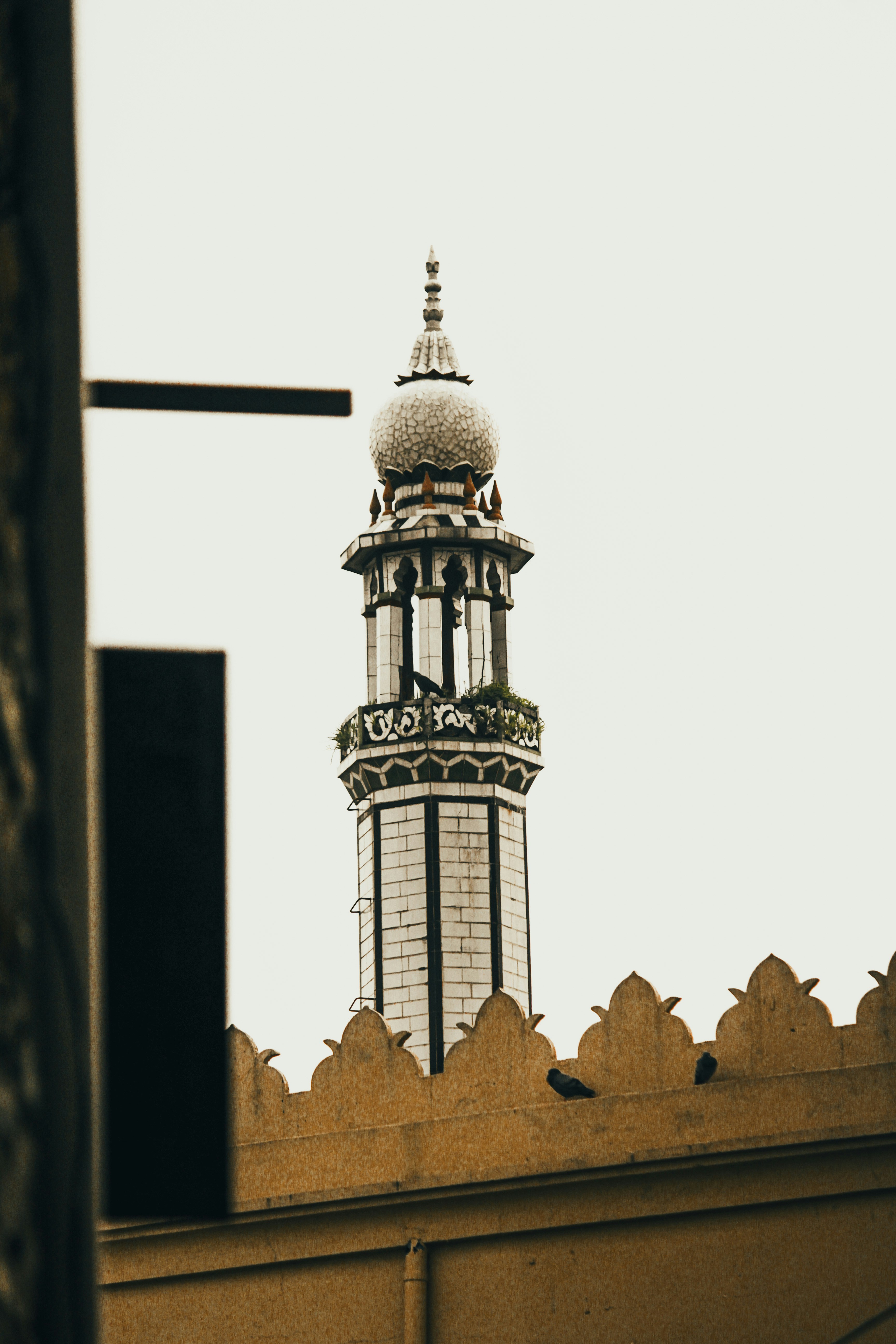 Spire Veil: A Desert Tower Peeking Between Urban Edges