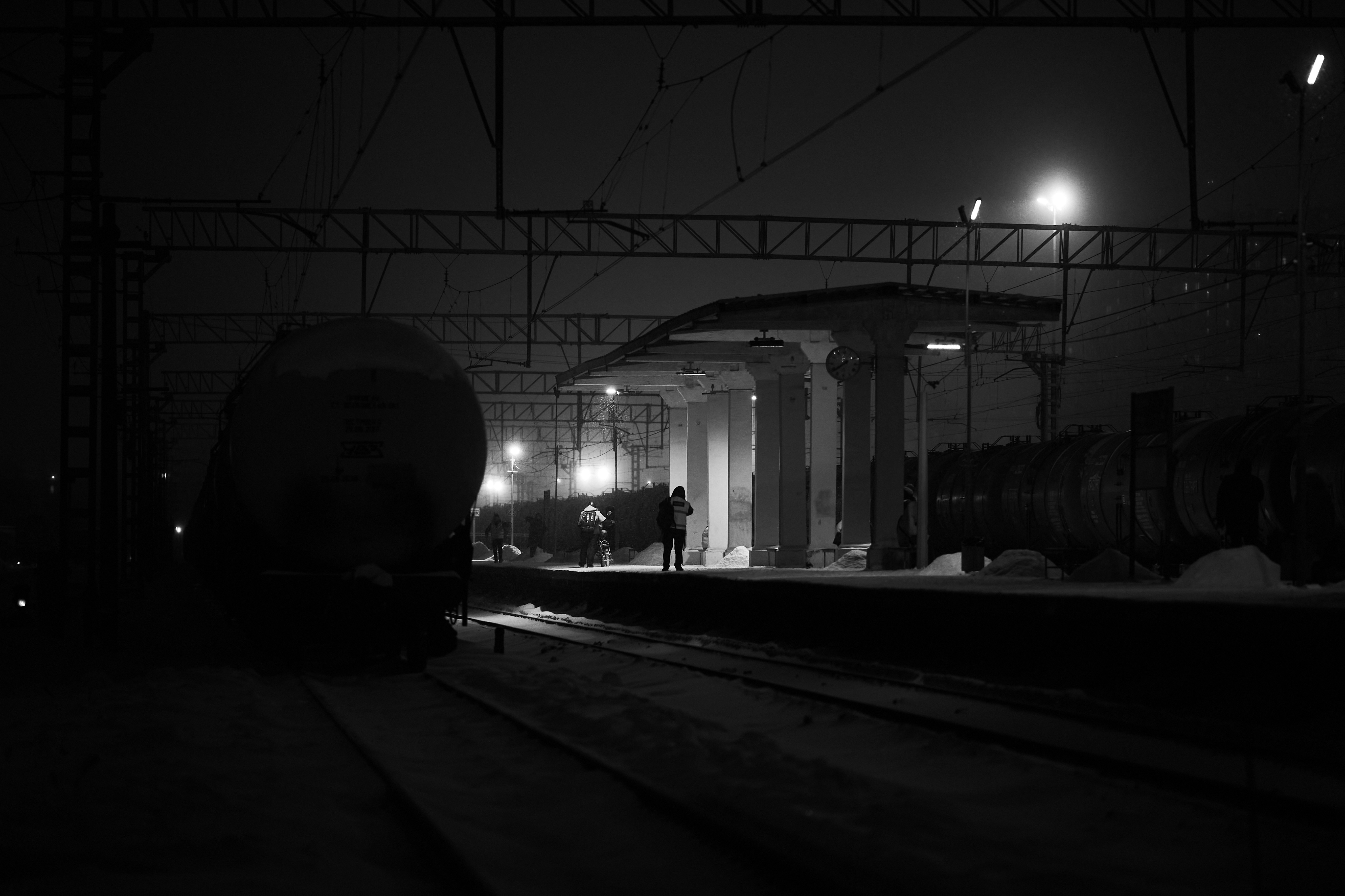 Midnight Platform: Workers in the Shadowed Train Yard