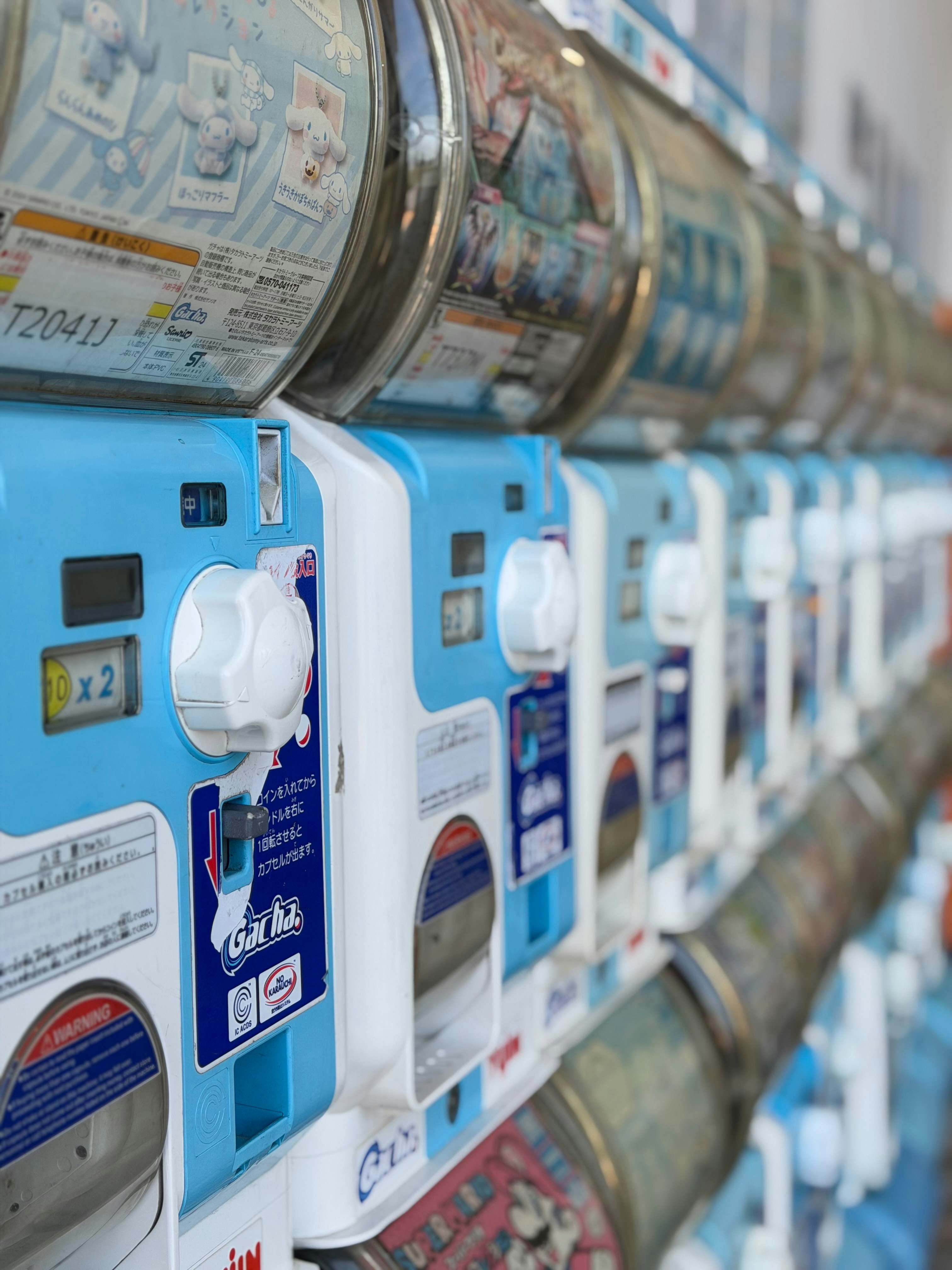 Blue Capsule Vending Row: Repetition and Color in Arcade Life