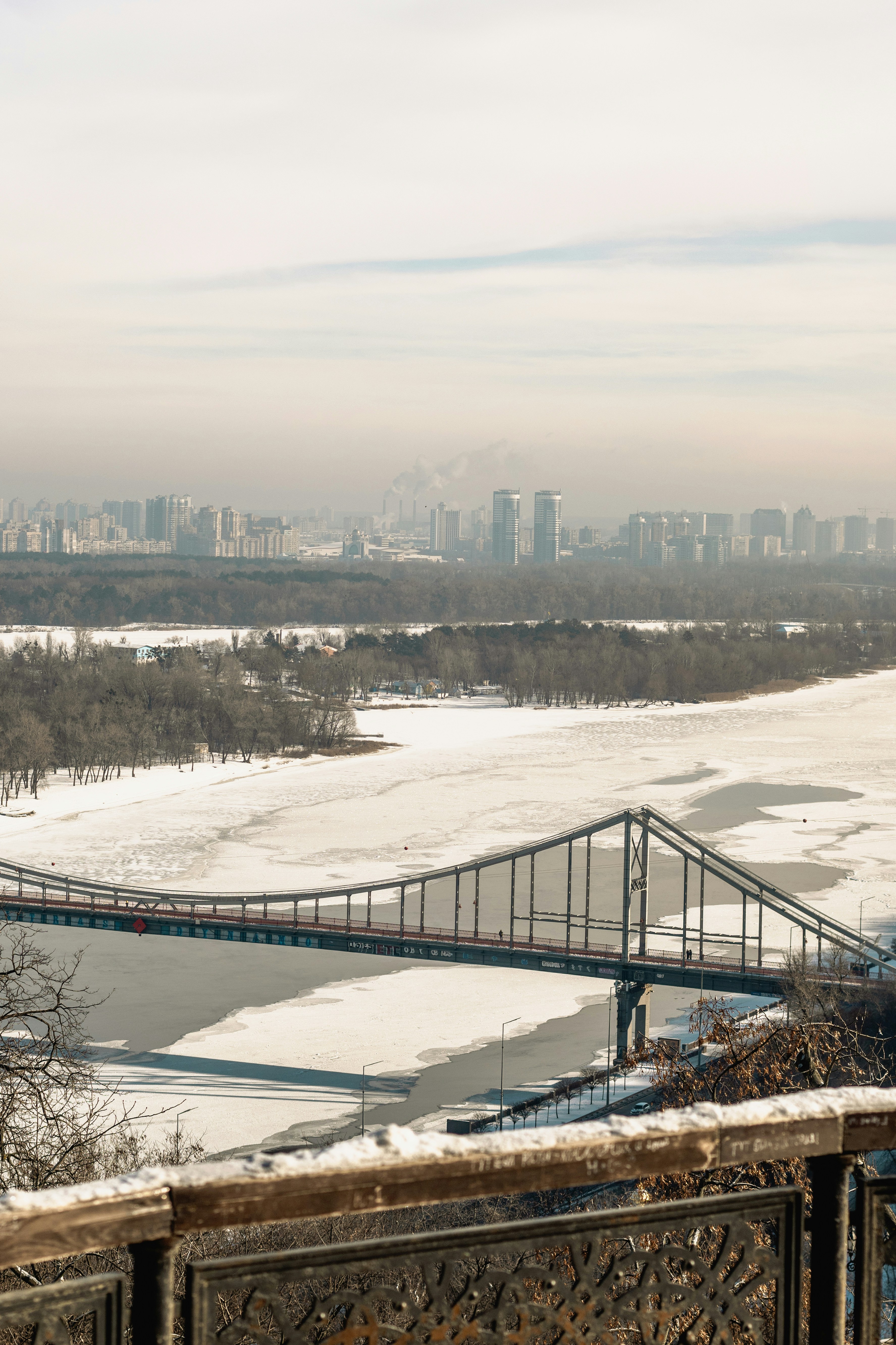 Winter City Strip: A Snow-Capped River Curves Under a Subway of Steel