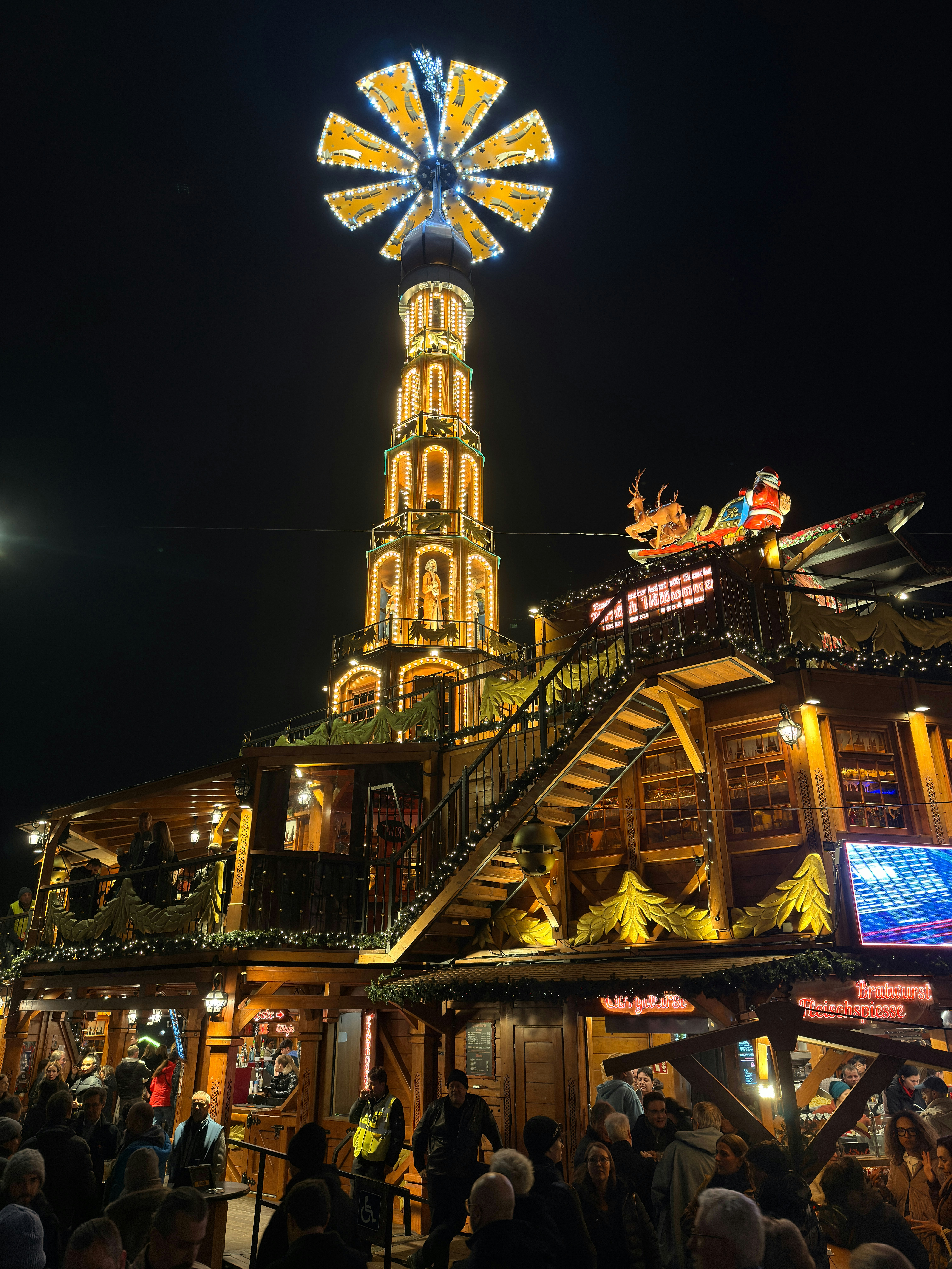 Nighttime Christmas Tower: Warm Lights Crown a Festive Chalet