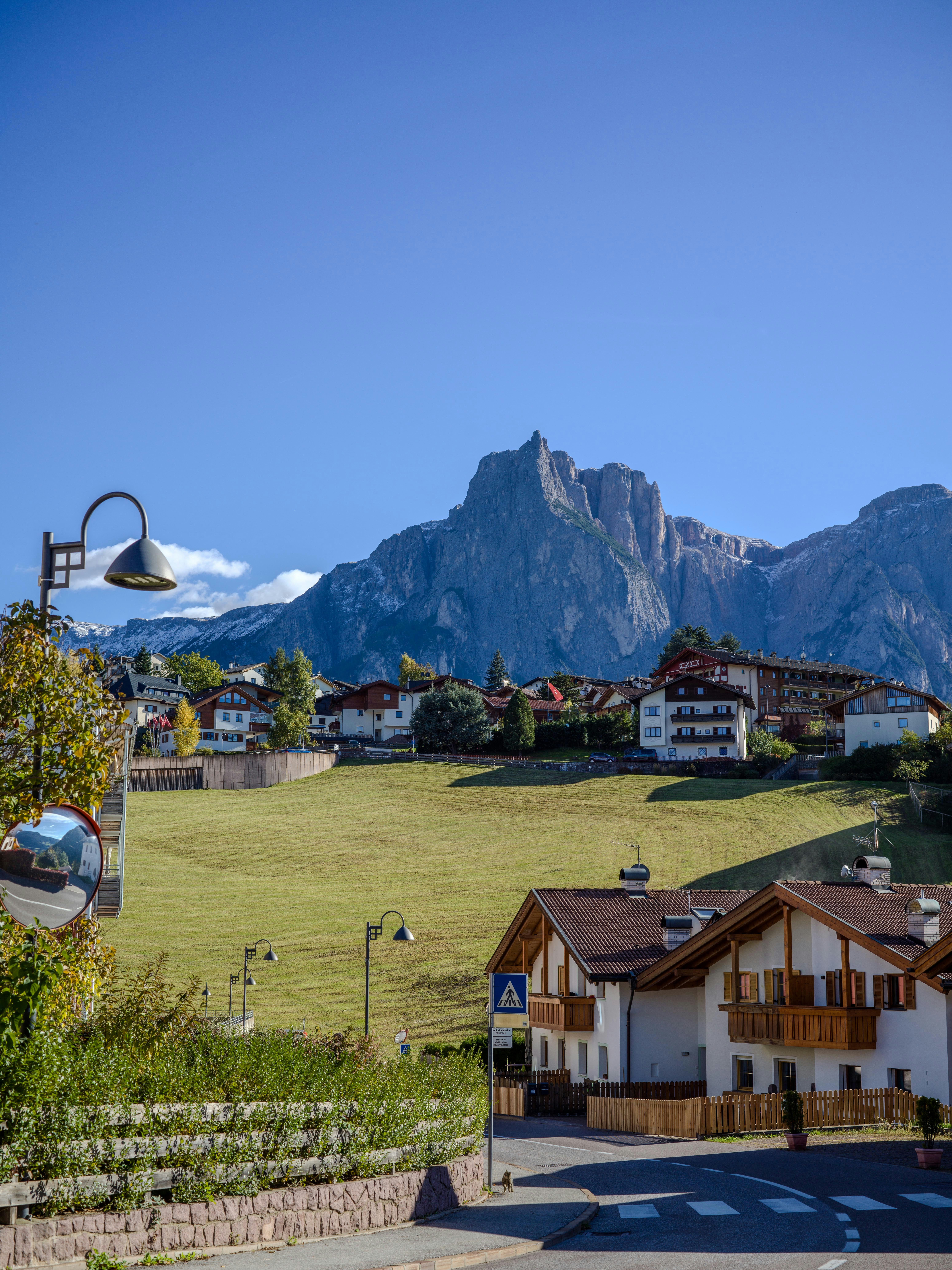 Alpine Village Beneath Rugged Peaks at Dusk