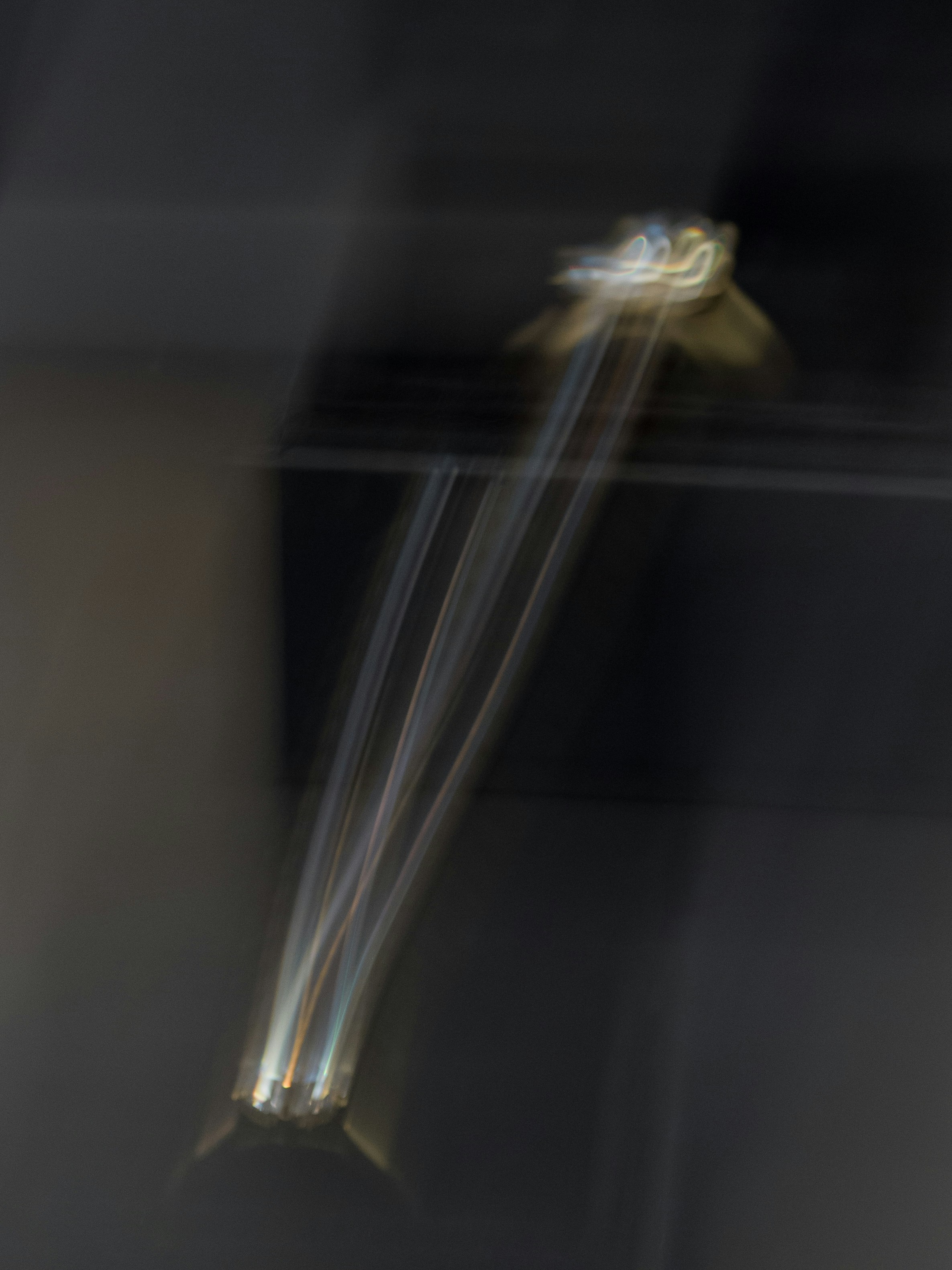 Trailing Light: A Blurred Spark of Motion in a Dark Frame