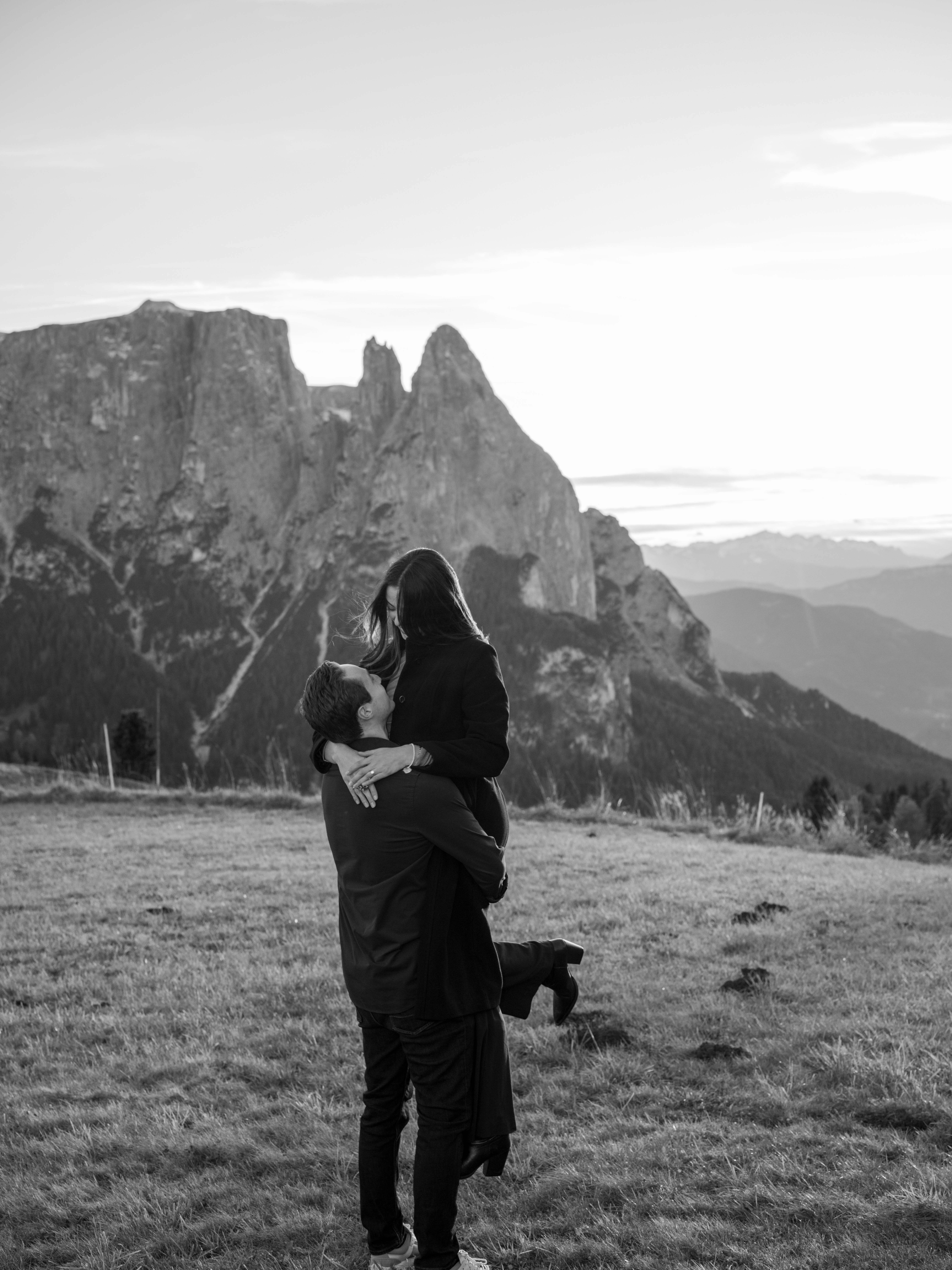 Embrace on the Mountain: A Lift Between Lovers as Peaks Glow