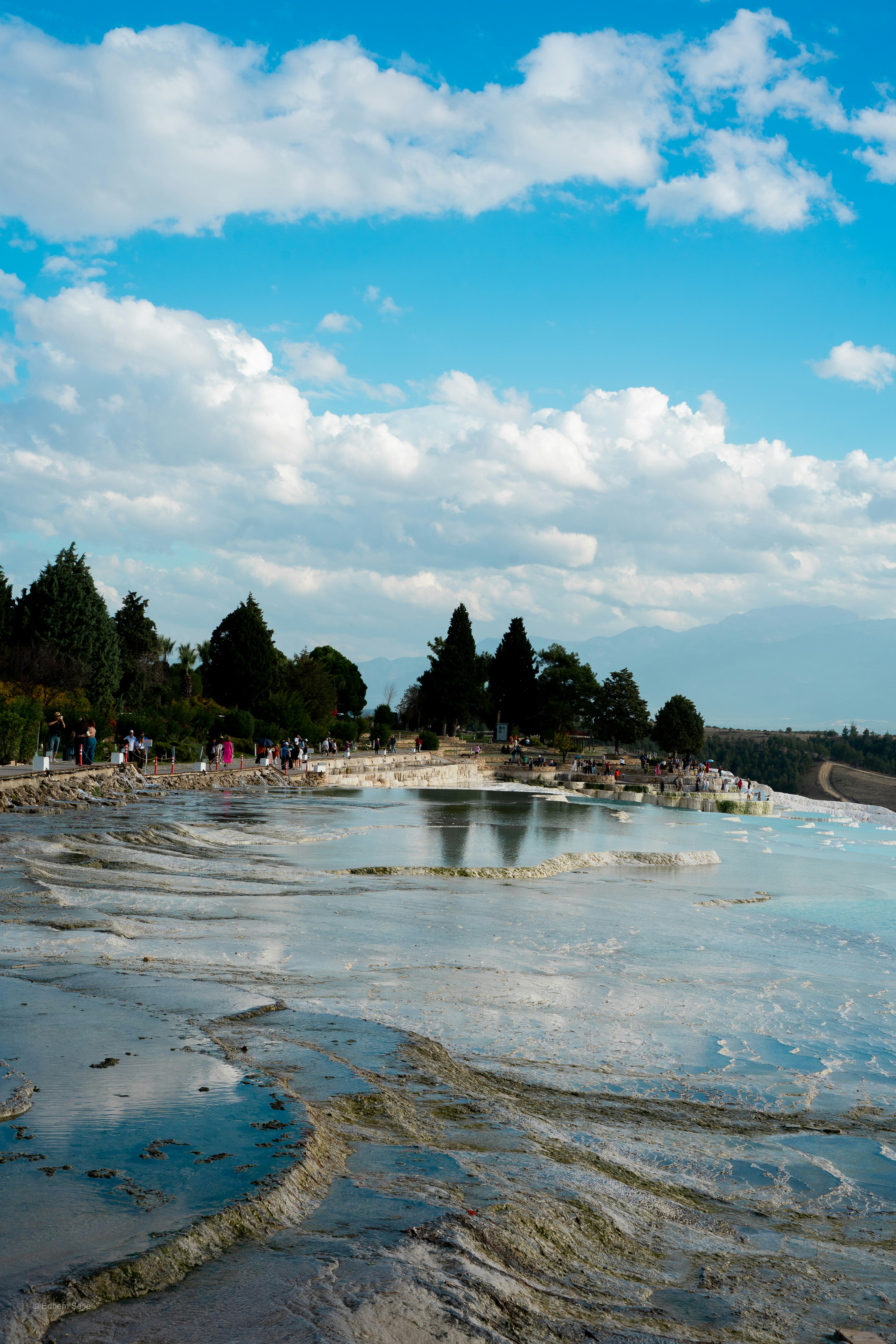 Terraced Mineral Pools Under a Bright Sky