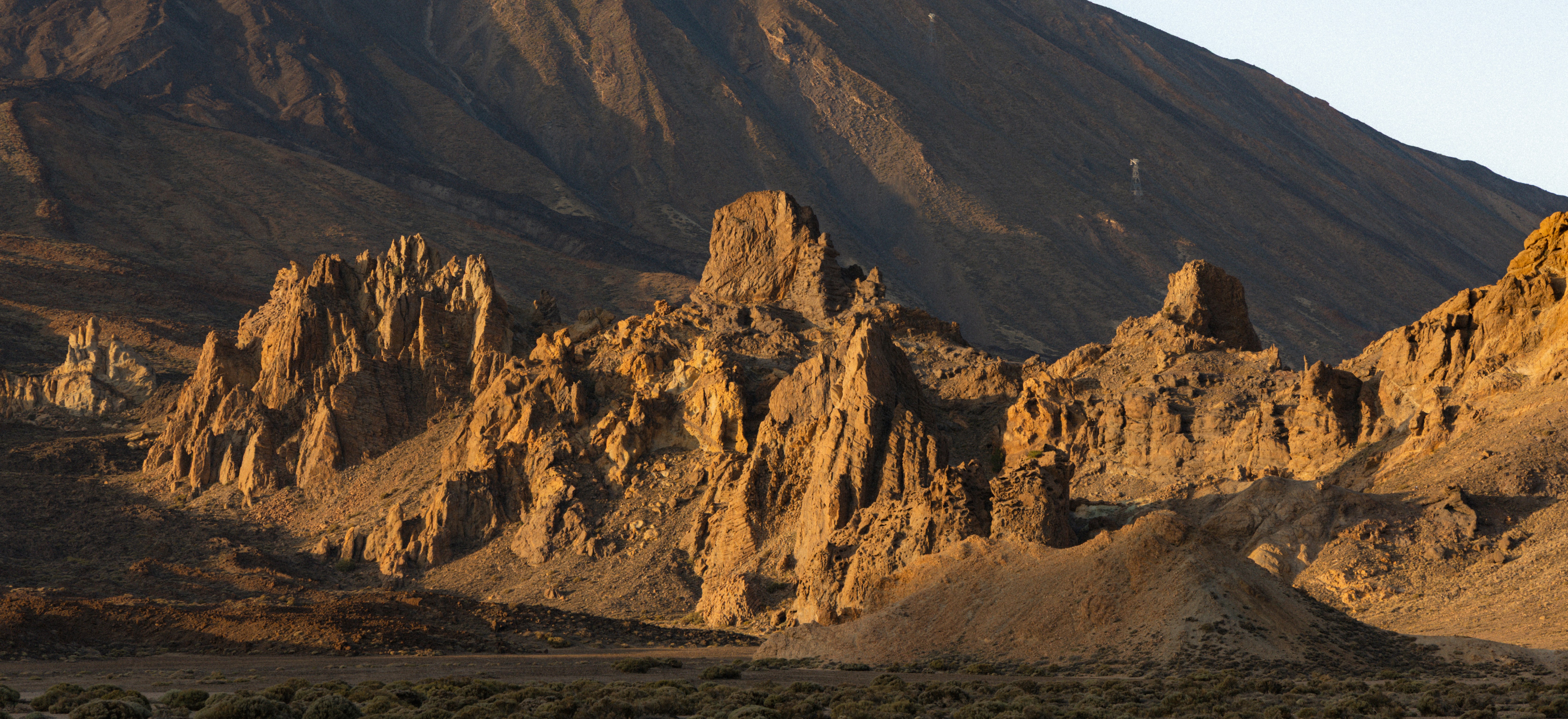 Golden Ridge: Sunlit Tapestry of Eroded Peaks