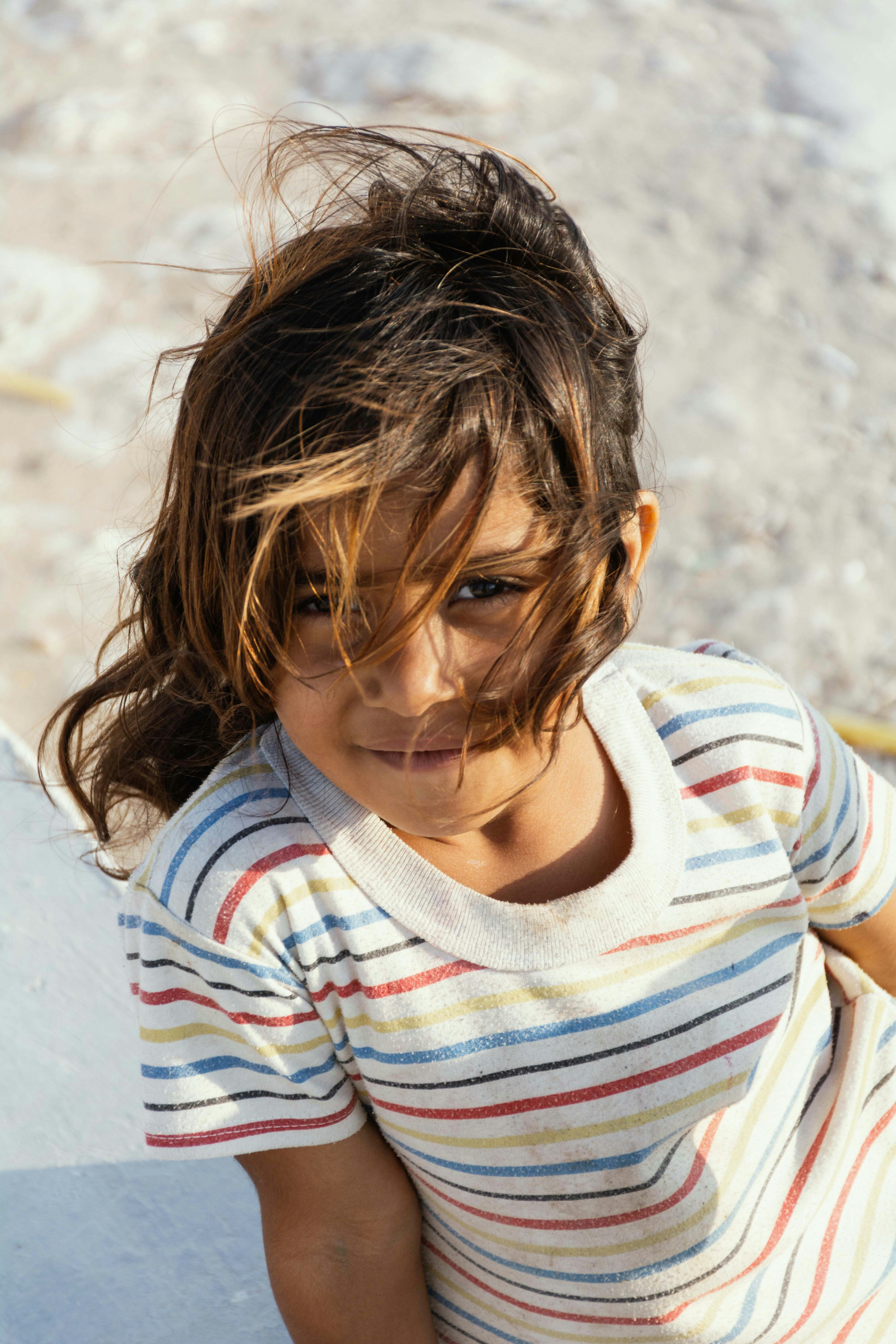 Wind in the Hair, Sunlit Portrait on a Sandy Shore