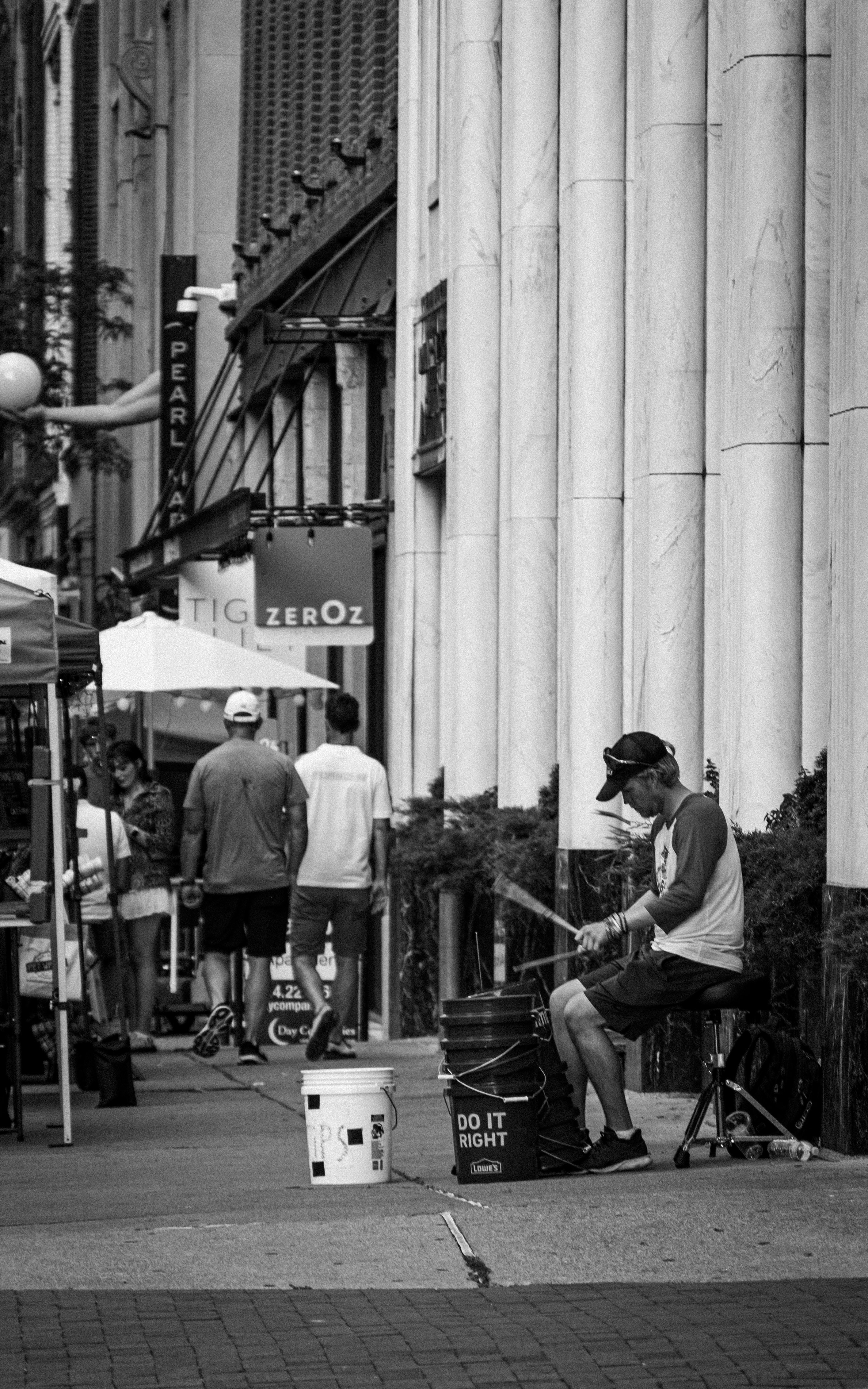 Street Busker in Front of Marble Columns