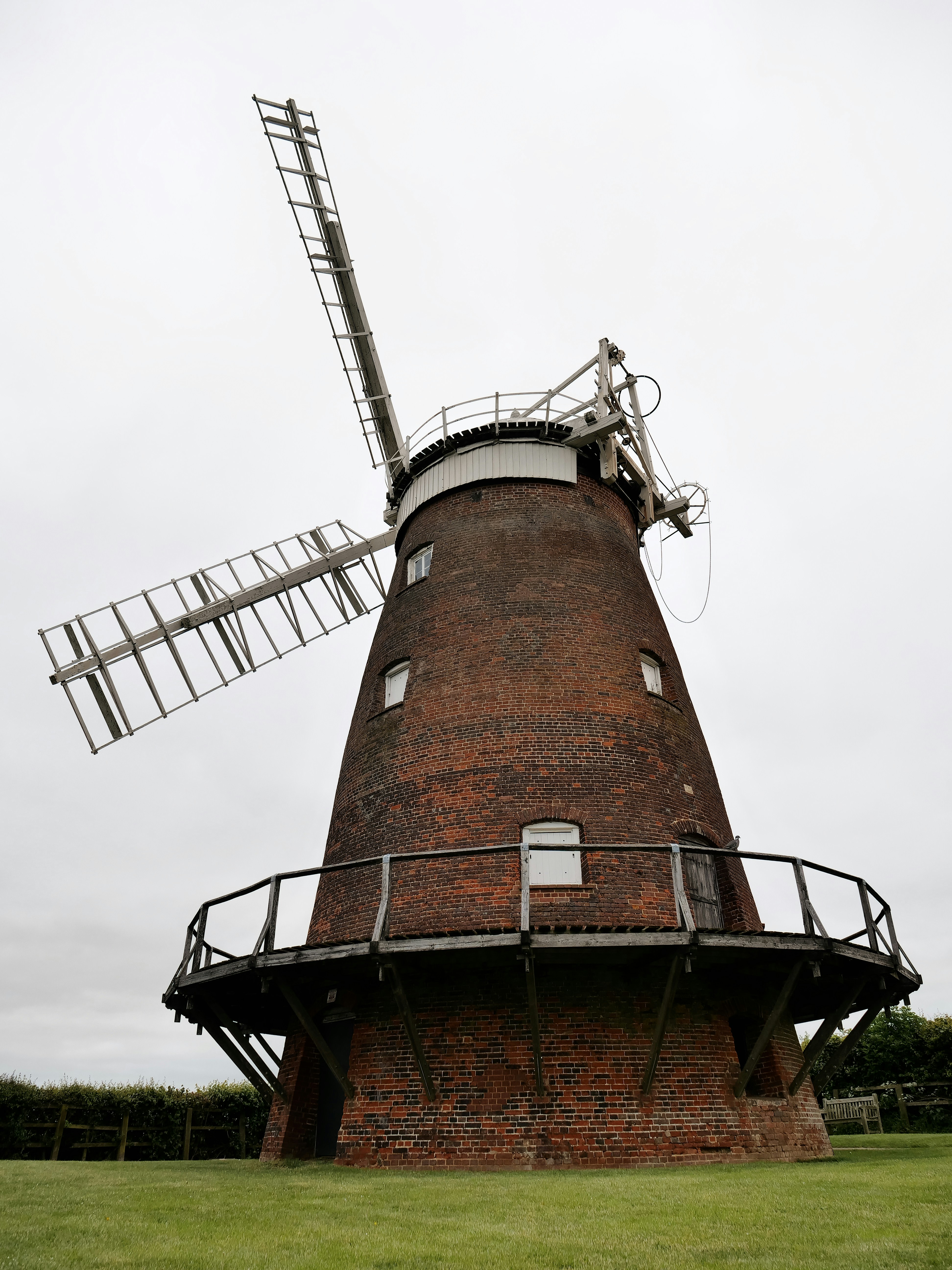 Brick Windmill Reaches Skyward with Iron Sail Blades