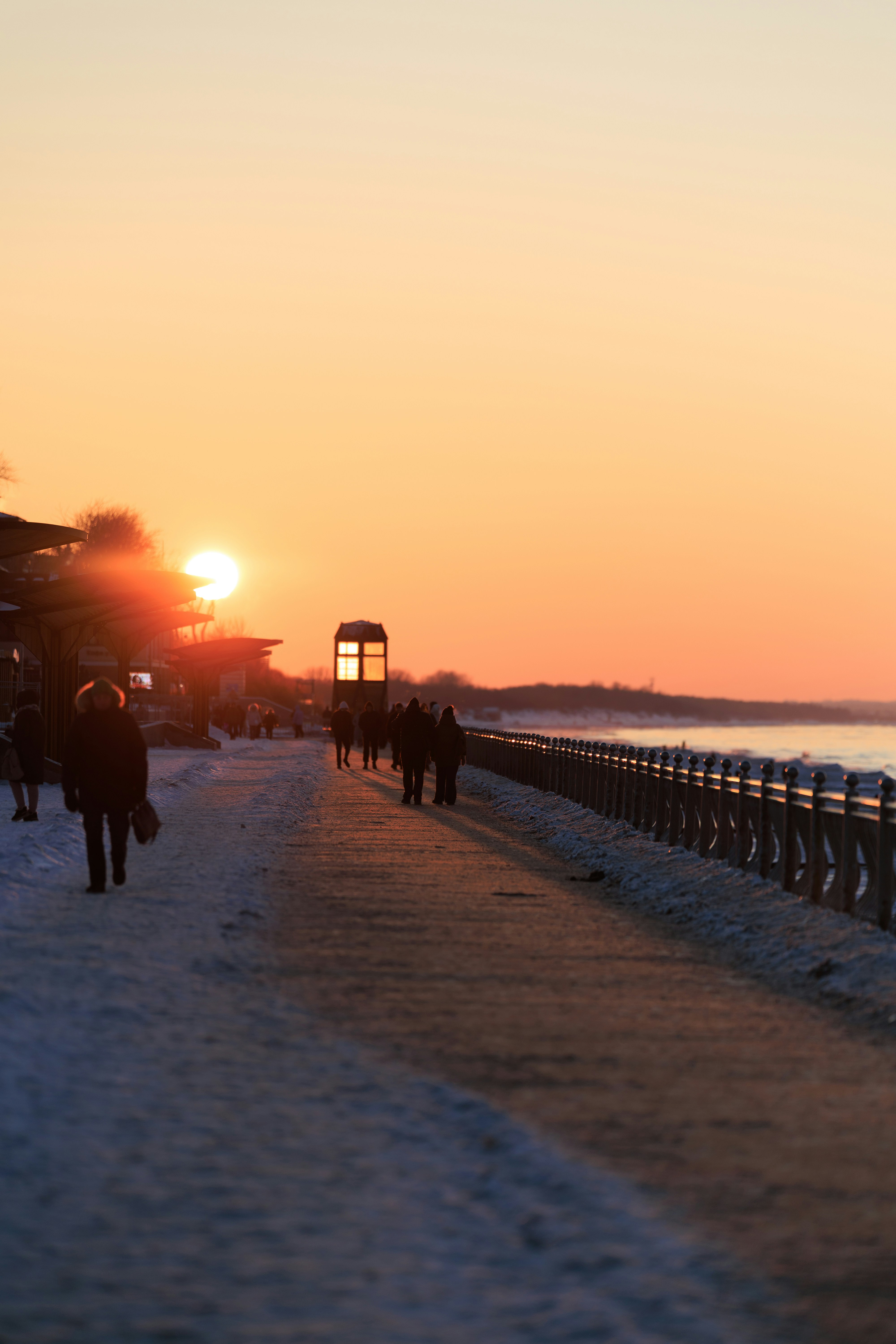 Sunset Promenade by the Snow-touched Sea Wall