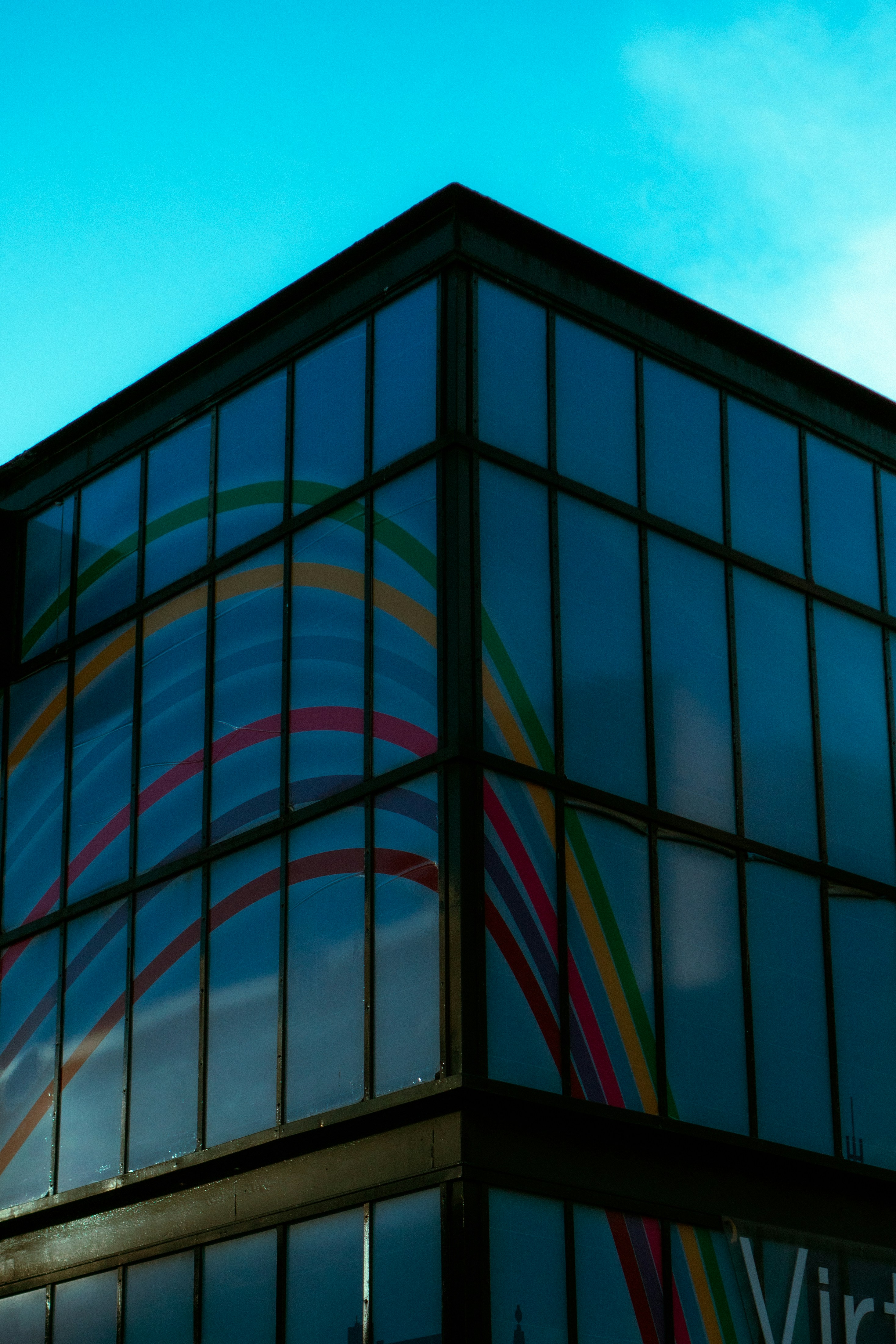 Glass Facade Arcs: A Corner of Colorful Reflections
