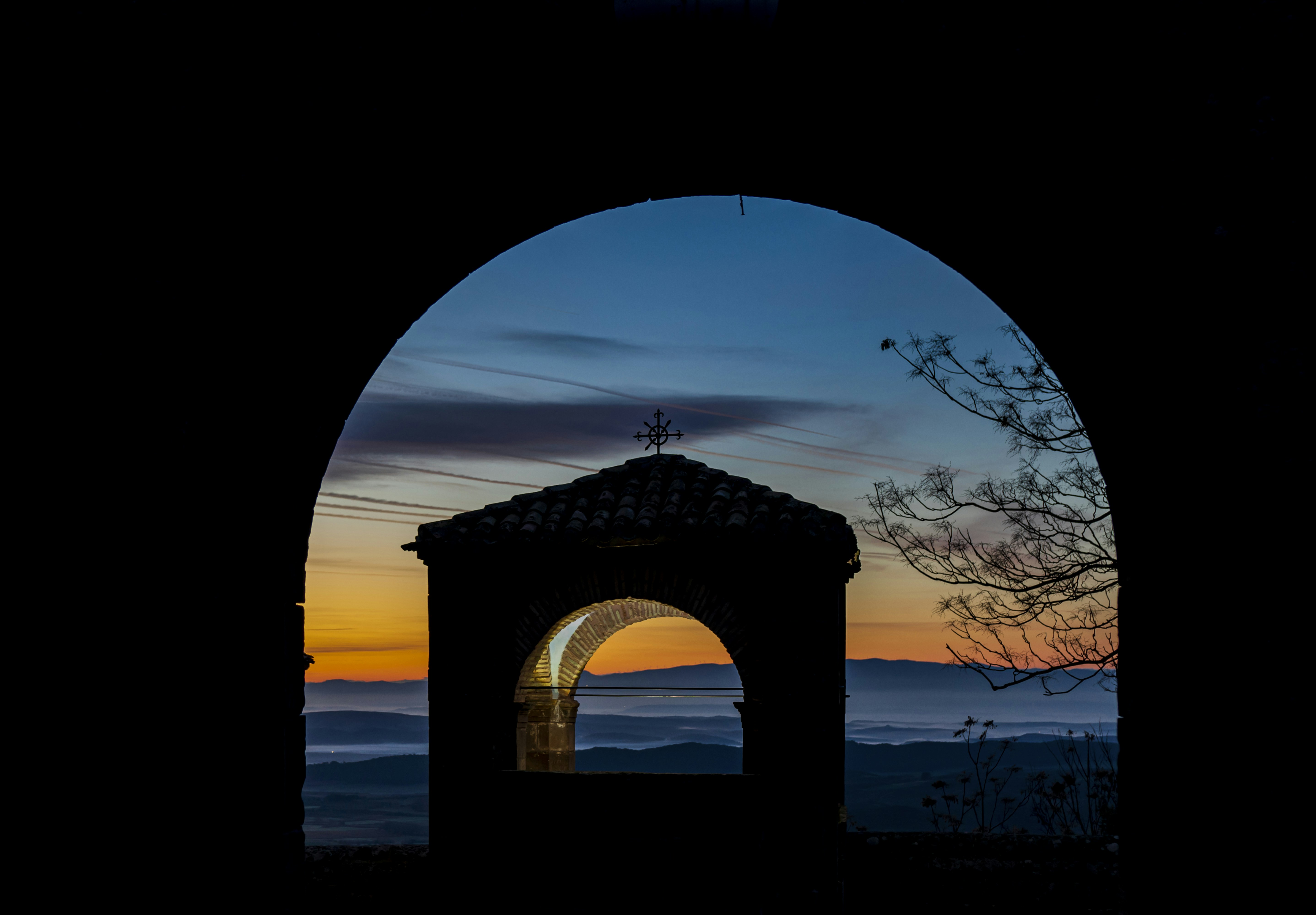Archway Framed by Dusk: A silhouette against a desert horizon