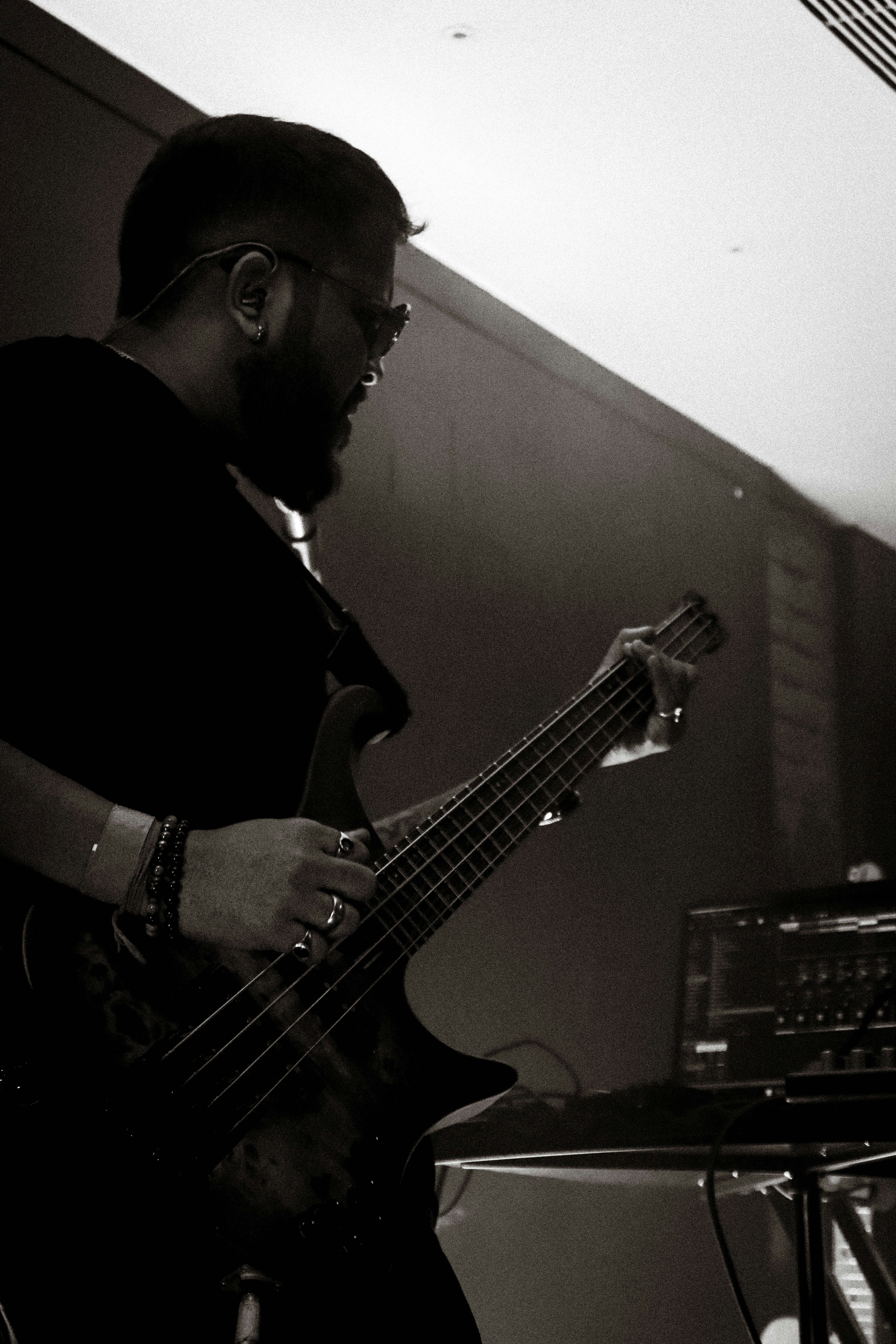 Low-lit Groove: A Bassist Under Streetlight Shadows