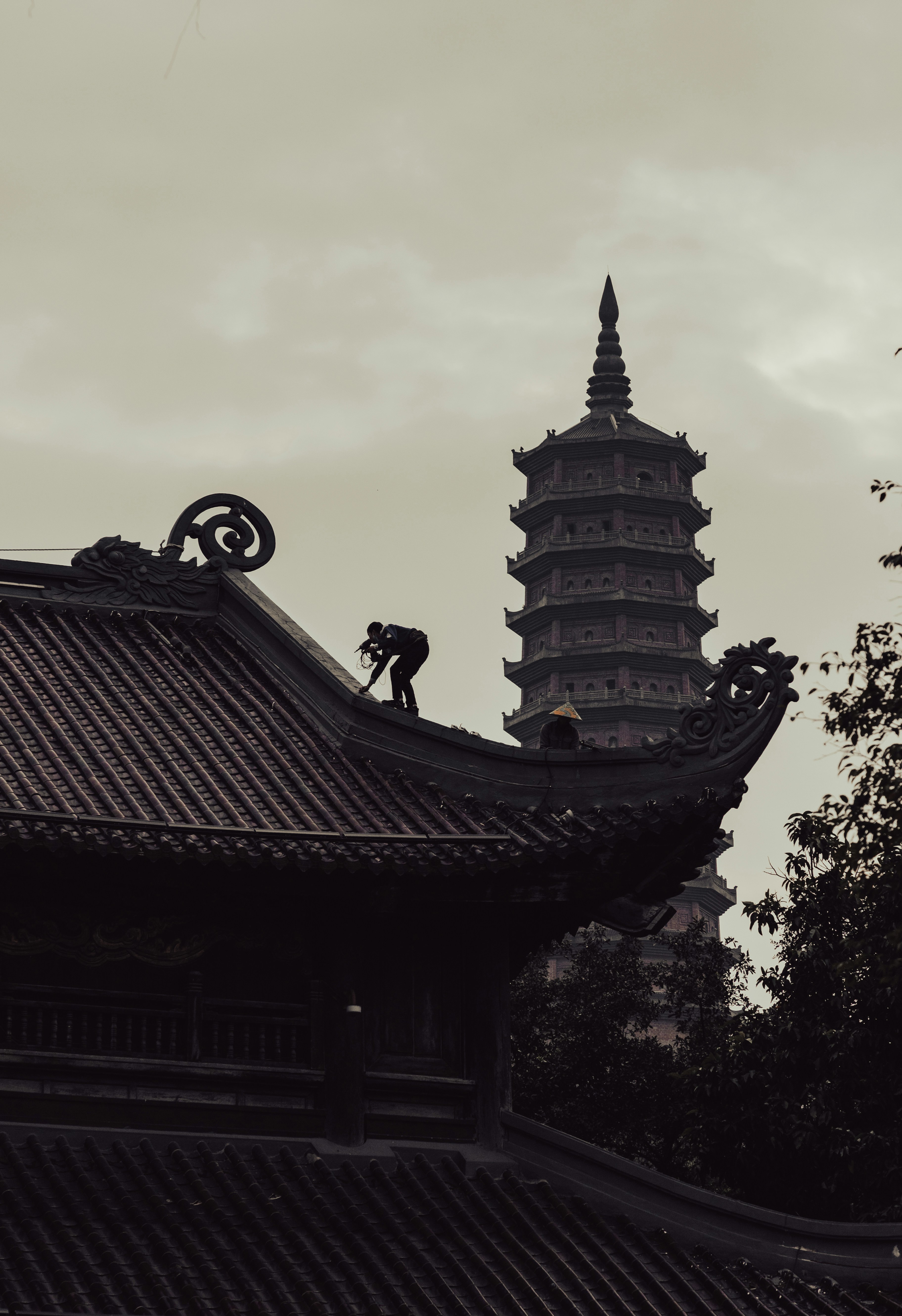 Silhouette of Craft and Tower: A Rooftop Moment Over an Ancient Pagoda