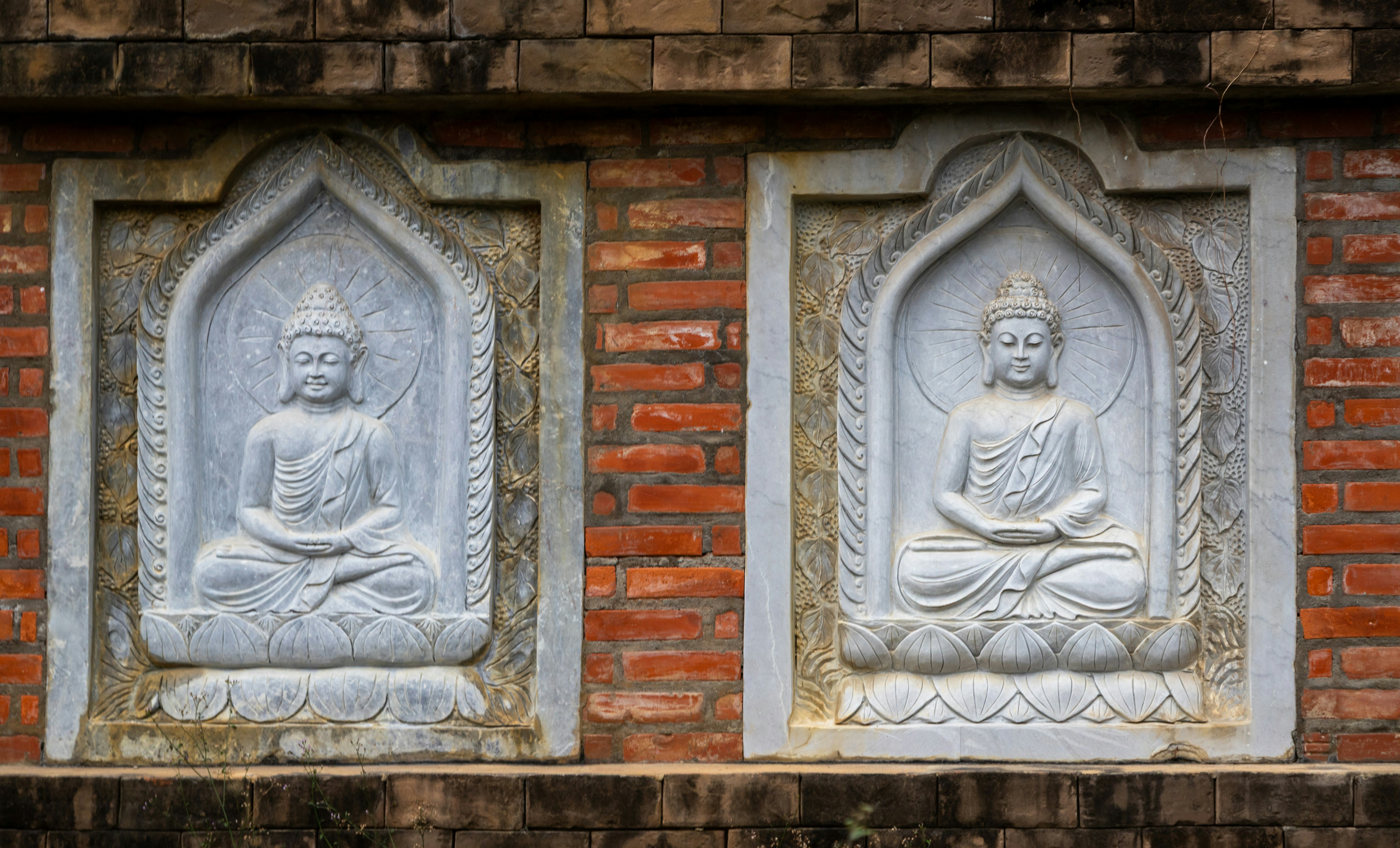 Twin Buddha Reliefs Framed by Time-worn Brickwork
