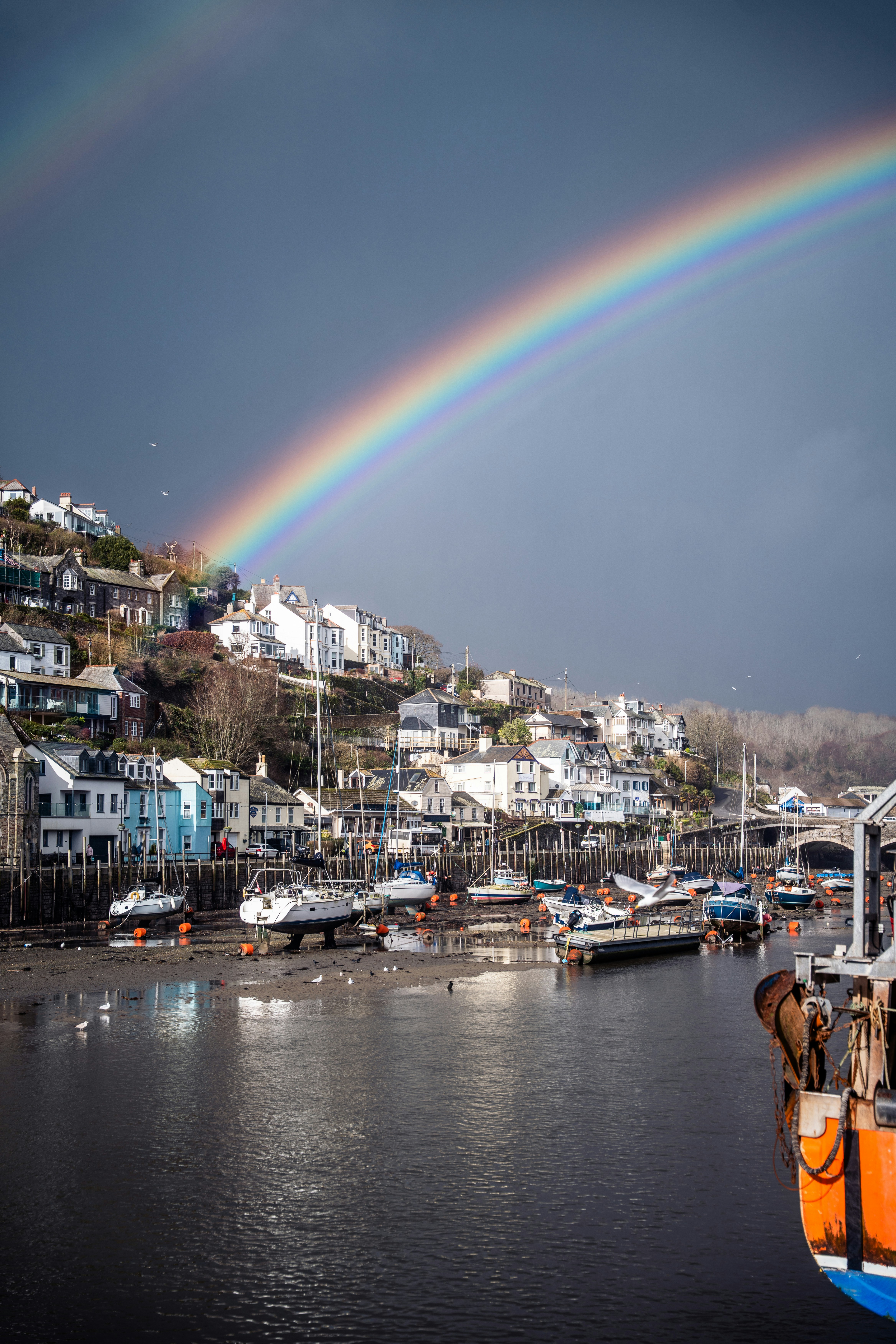 Rainbow Over a Quay: A Coastal Village Beneath Twin Arcs