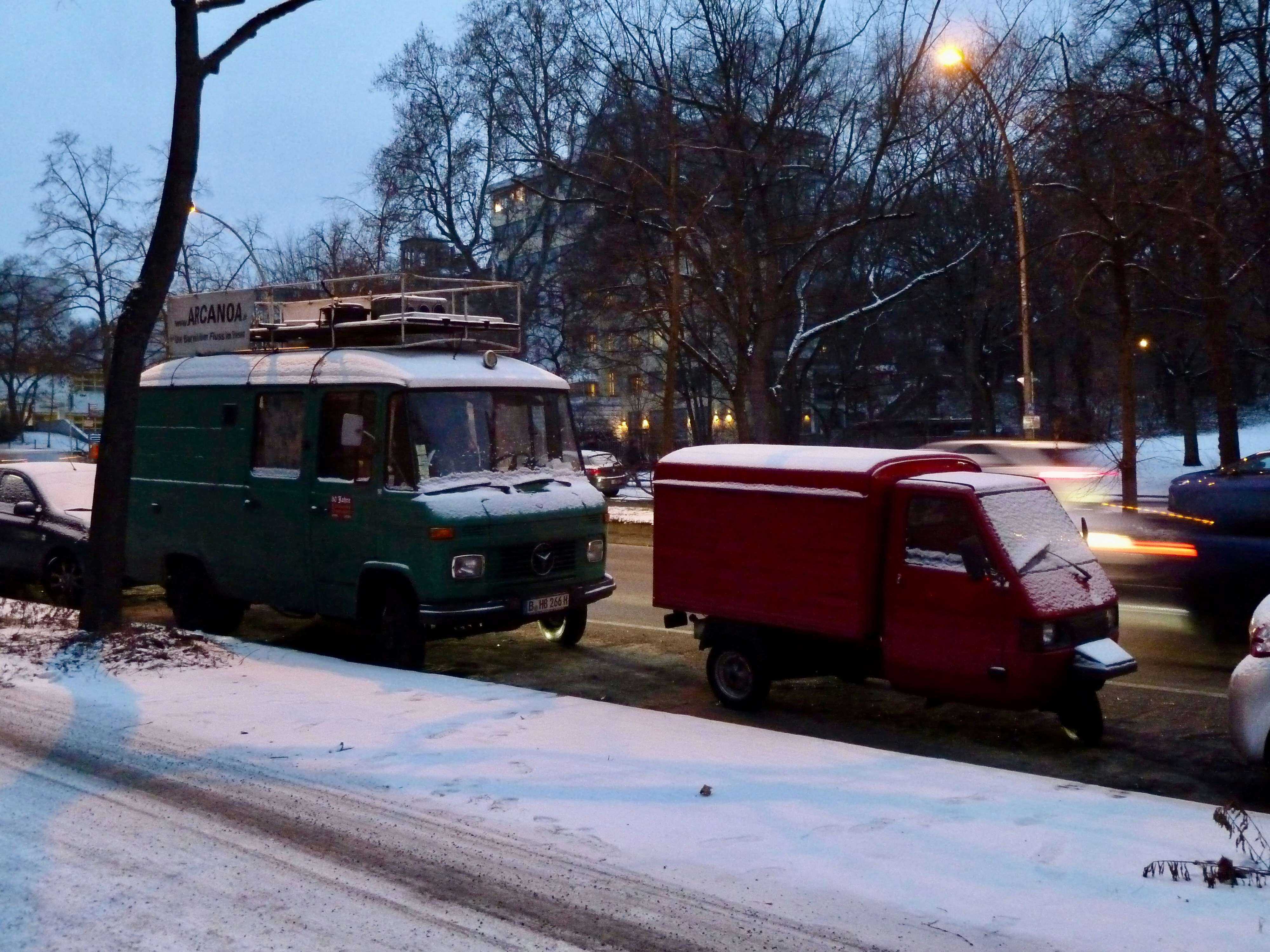 Two vehicles parked on a snowy street