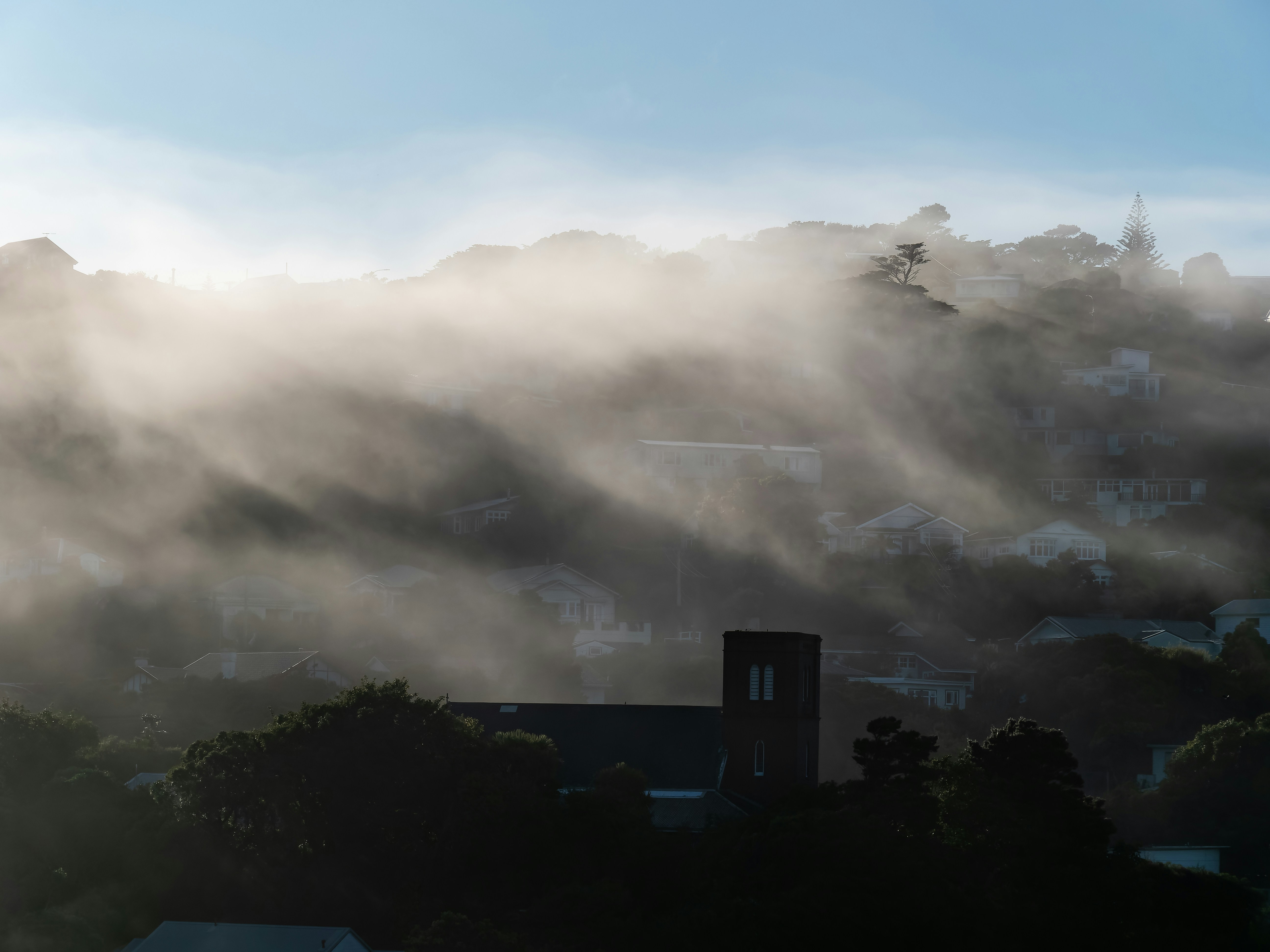 Fog Lifts Over a Quiet Hillside Town