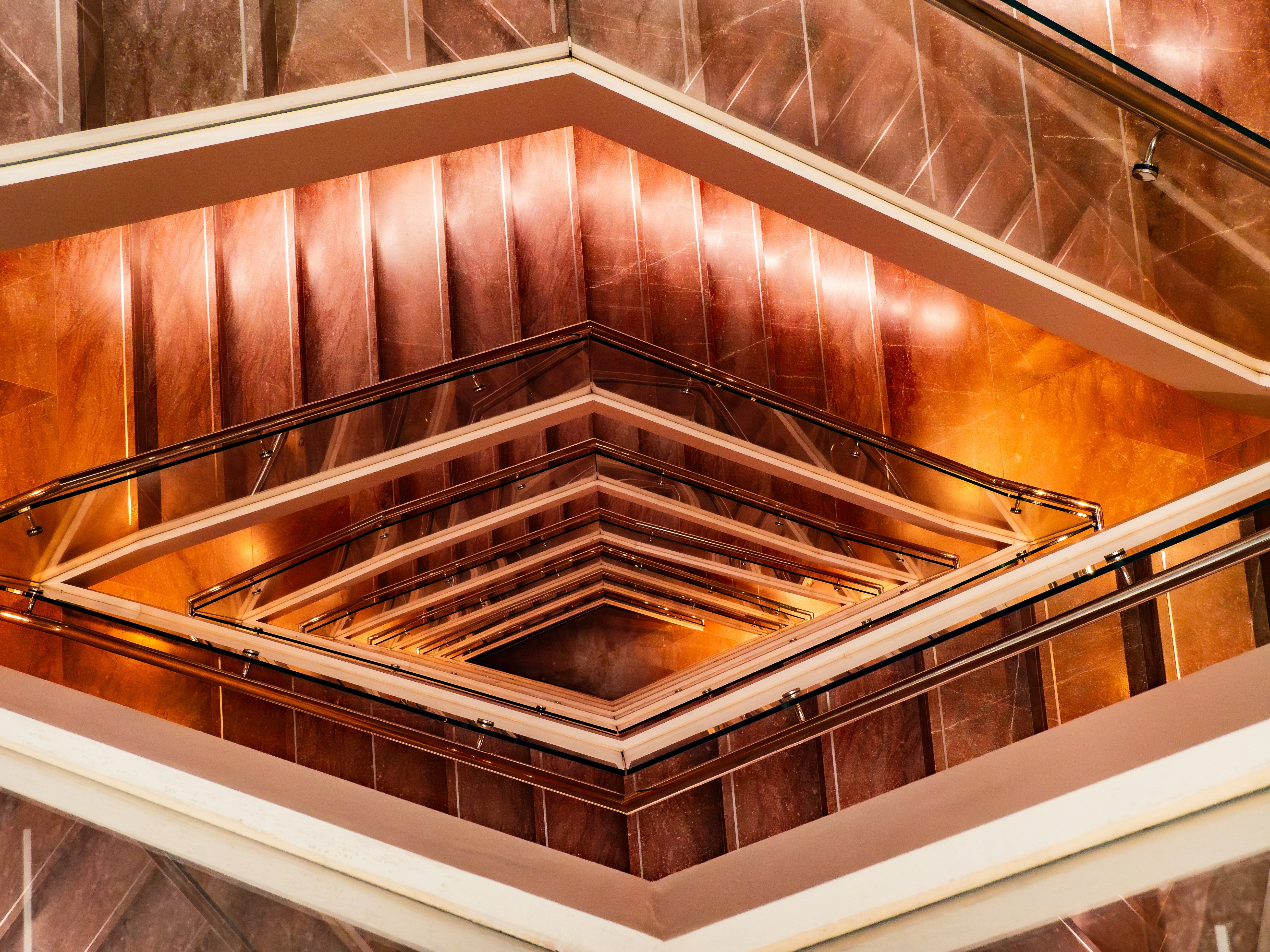 Geometric Reflections: Nested Atrium Angles in Warm Tone