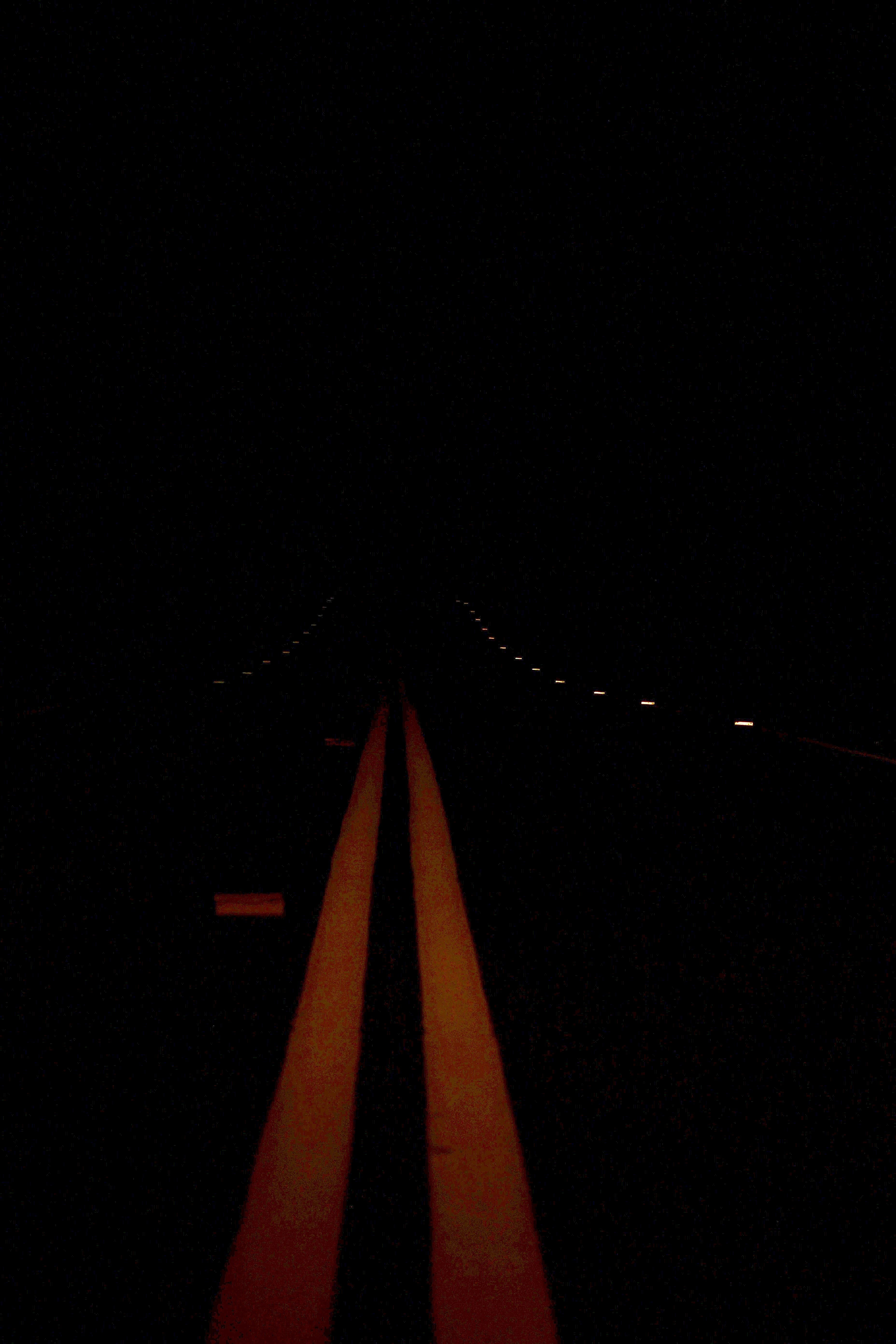 Headlights on a Desolate Highway: A Night Runway into Darkness