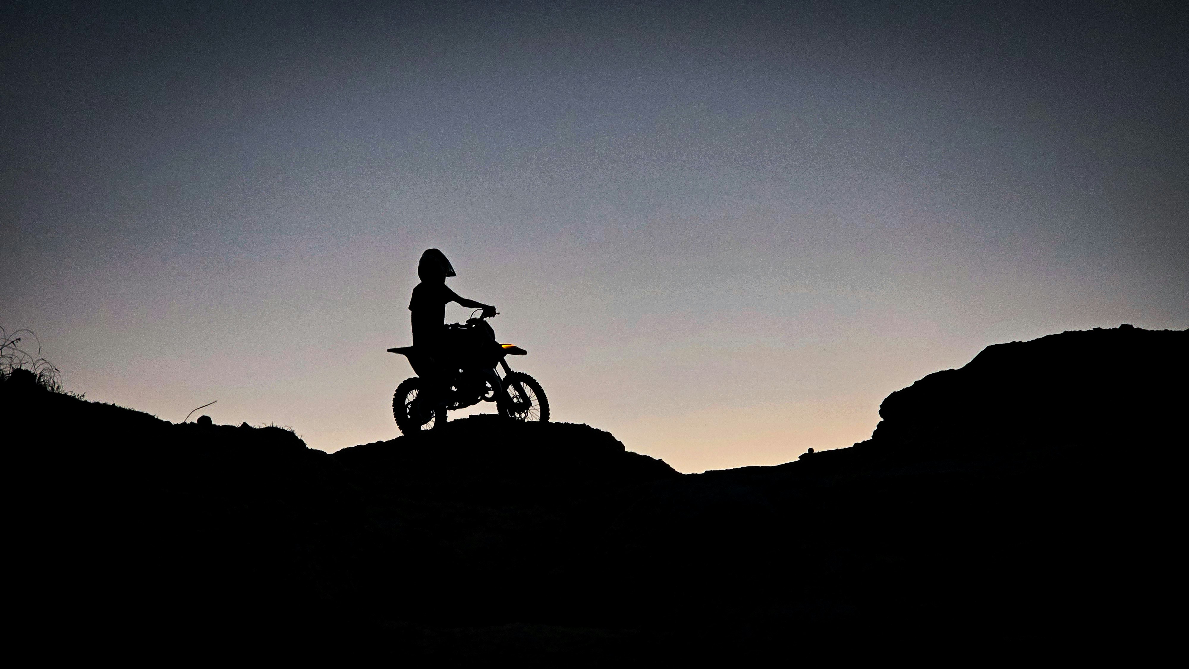 Silhouette Rider Against Dusk Ridge