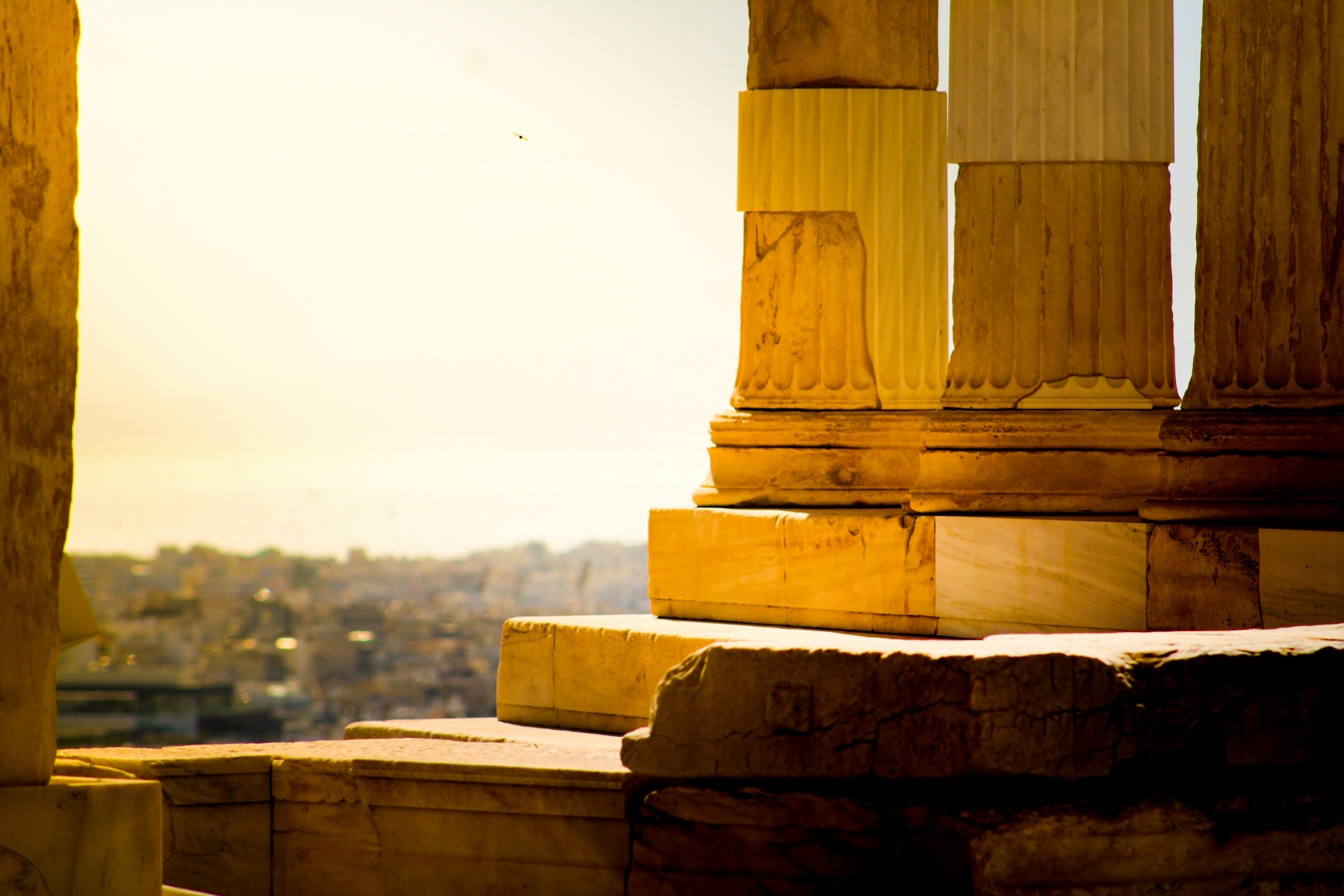 Stone Columns at Golden Hour: Ancient Structure Framing a Welcoming Horizon