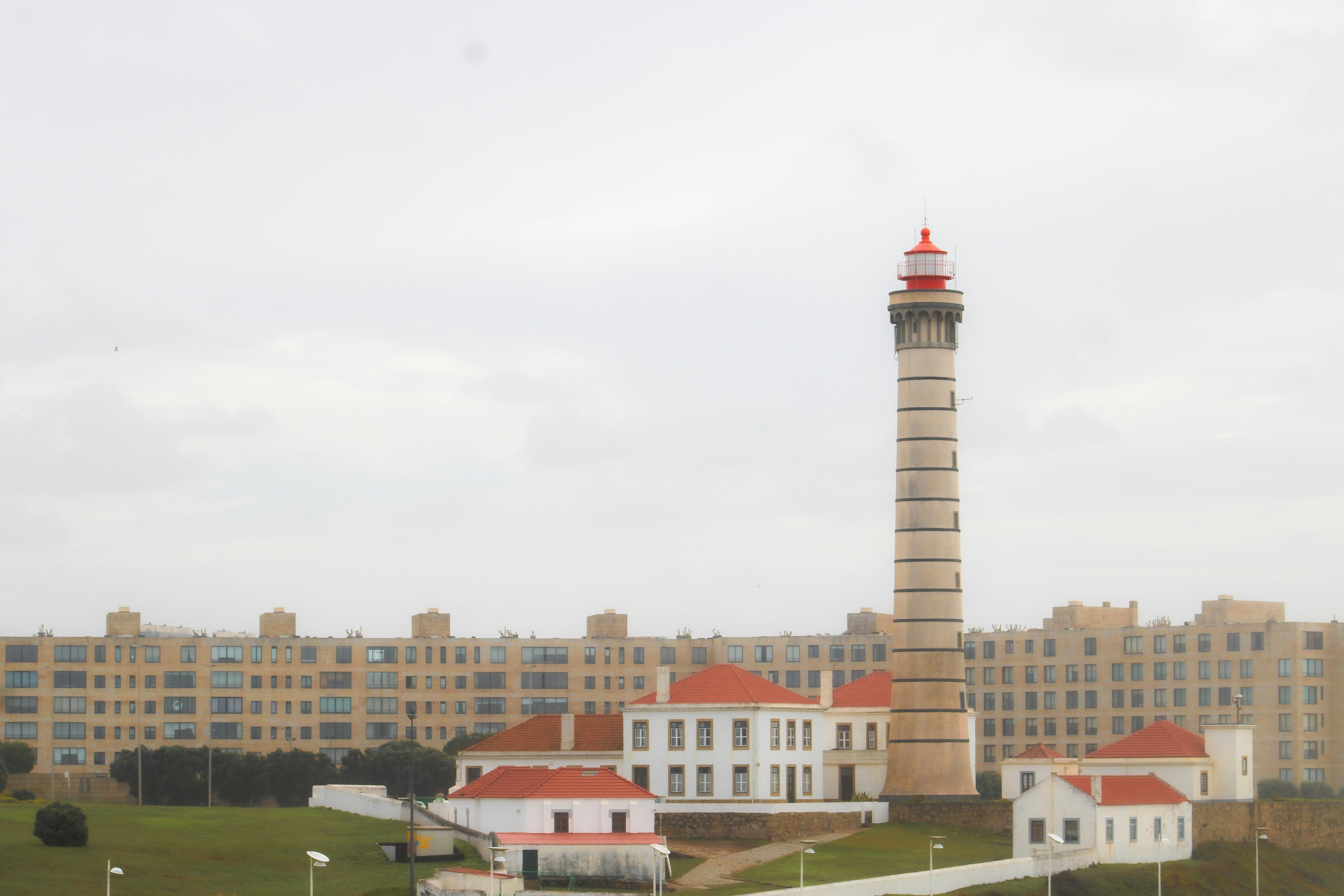 Lighthouse Sentinel above red-roofed Annexes on a Low-Density Campus
