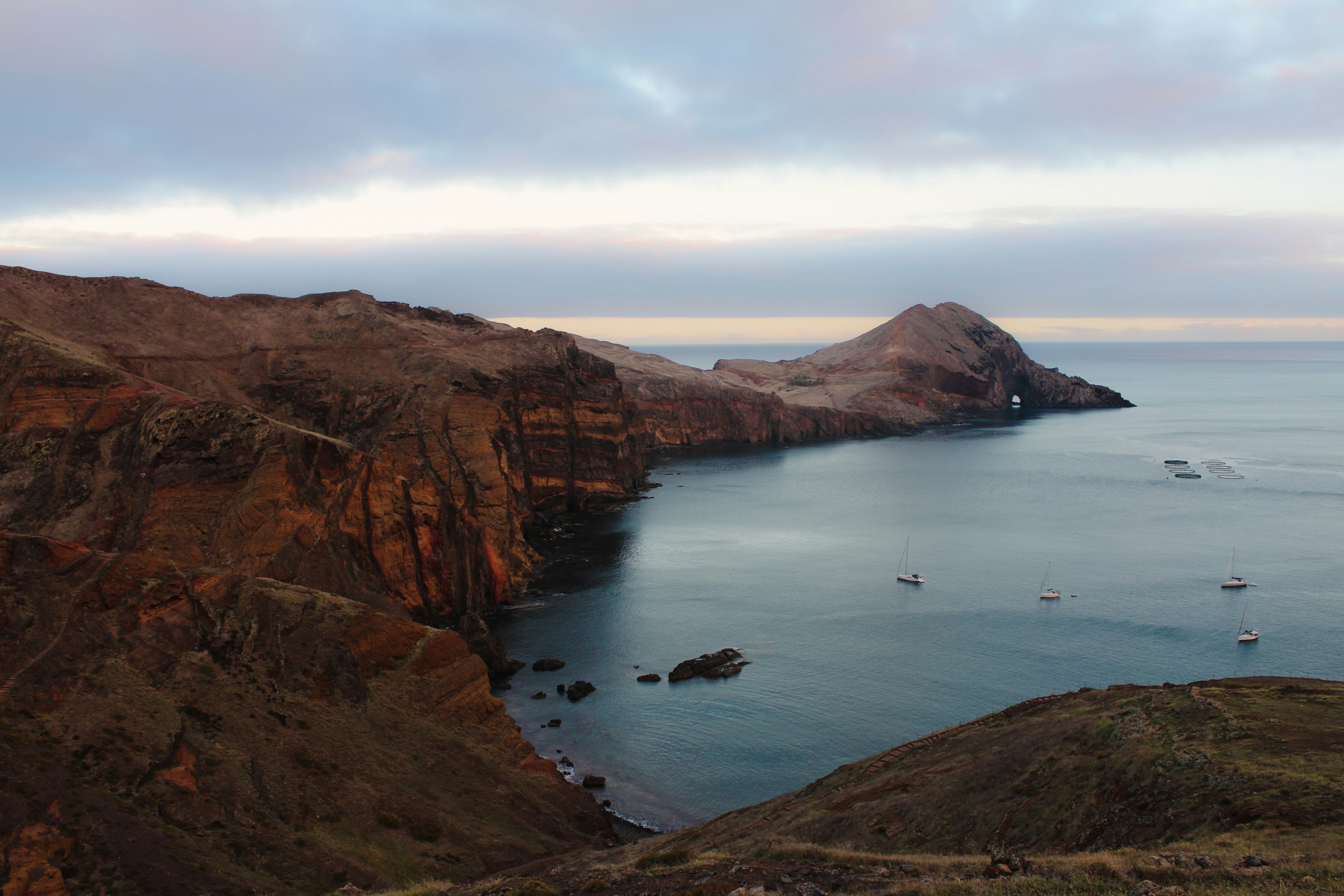 Coastal Cloak: Sunset Over the Curving Bay