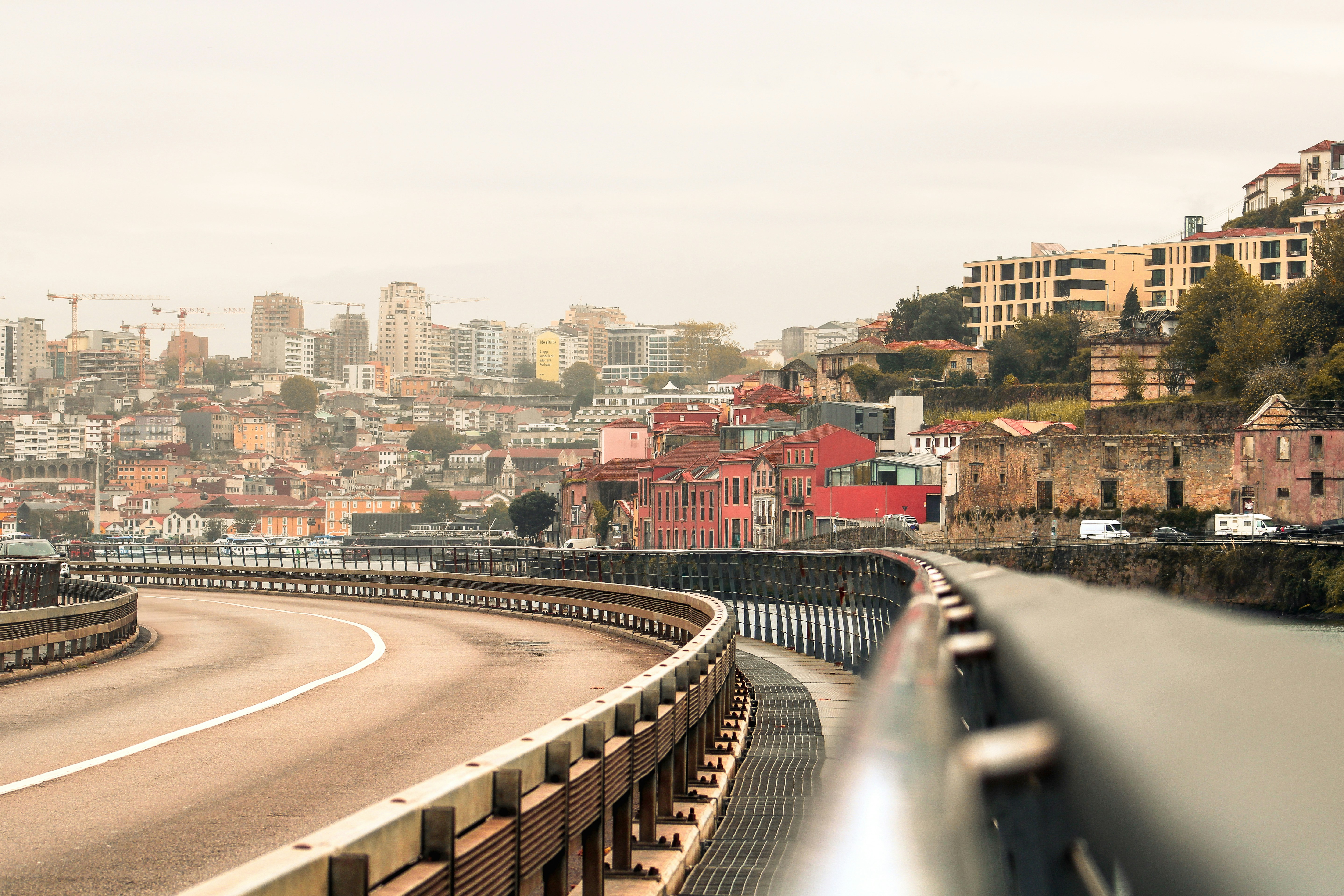 Coastal Curve: A Waterfront Road Framed by Distant Terracotta Hills